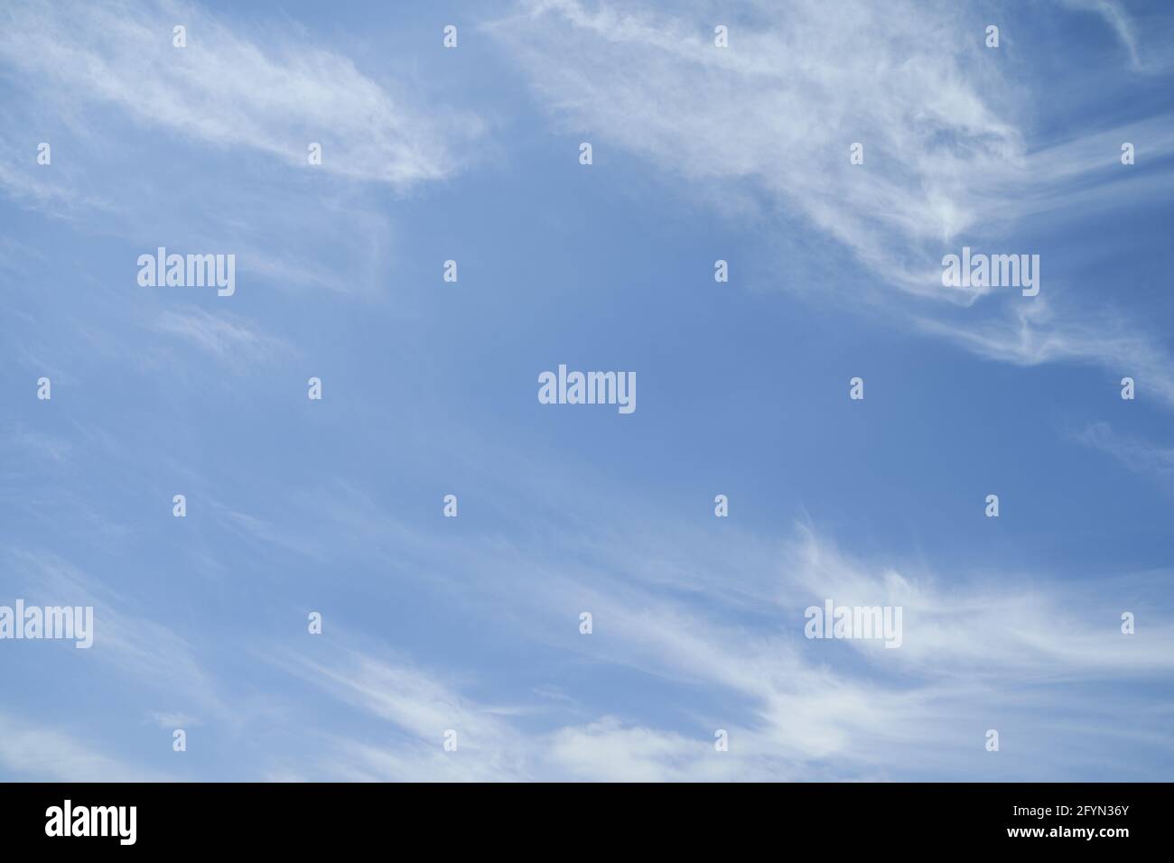 Pale blue sky on a sunny day filled with a sea of smoky white clouds ...