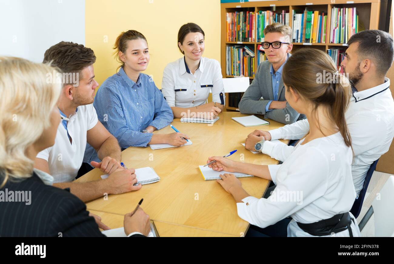 Adult students with female teacher studying in classroom Stock Photo ...