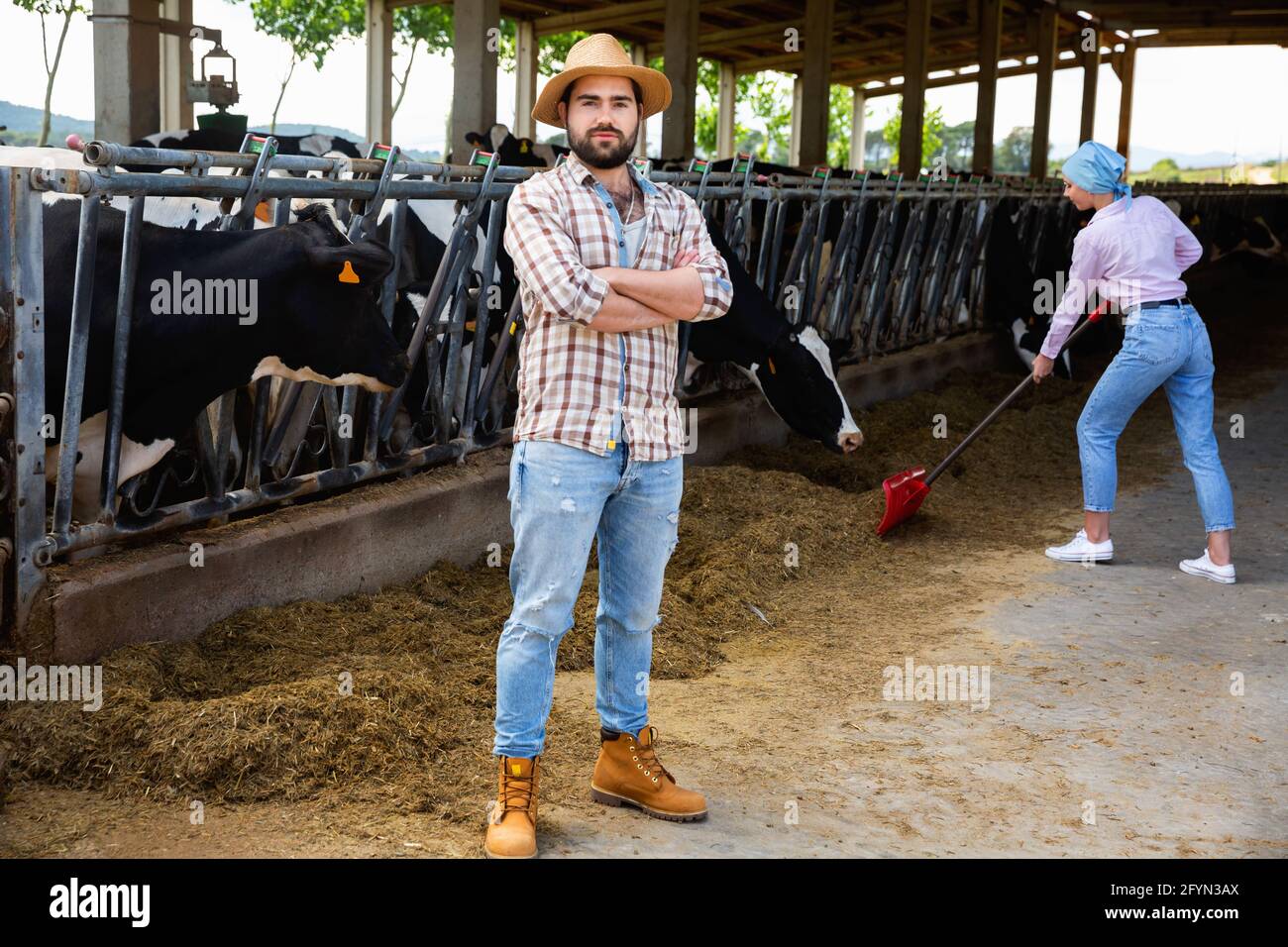 Confident young happy cheerful smiling man owner of dairy farm standing ...