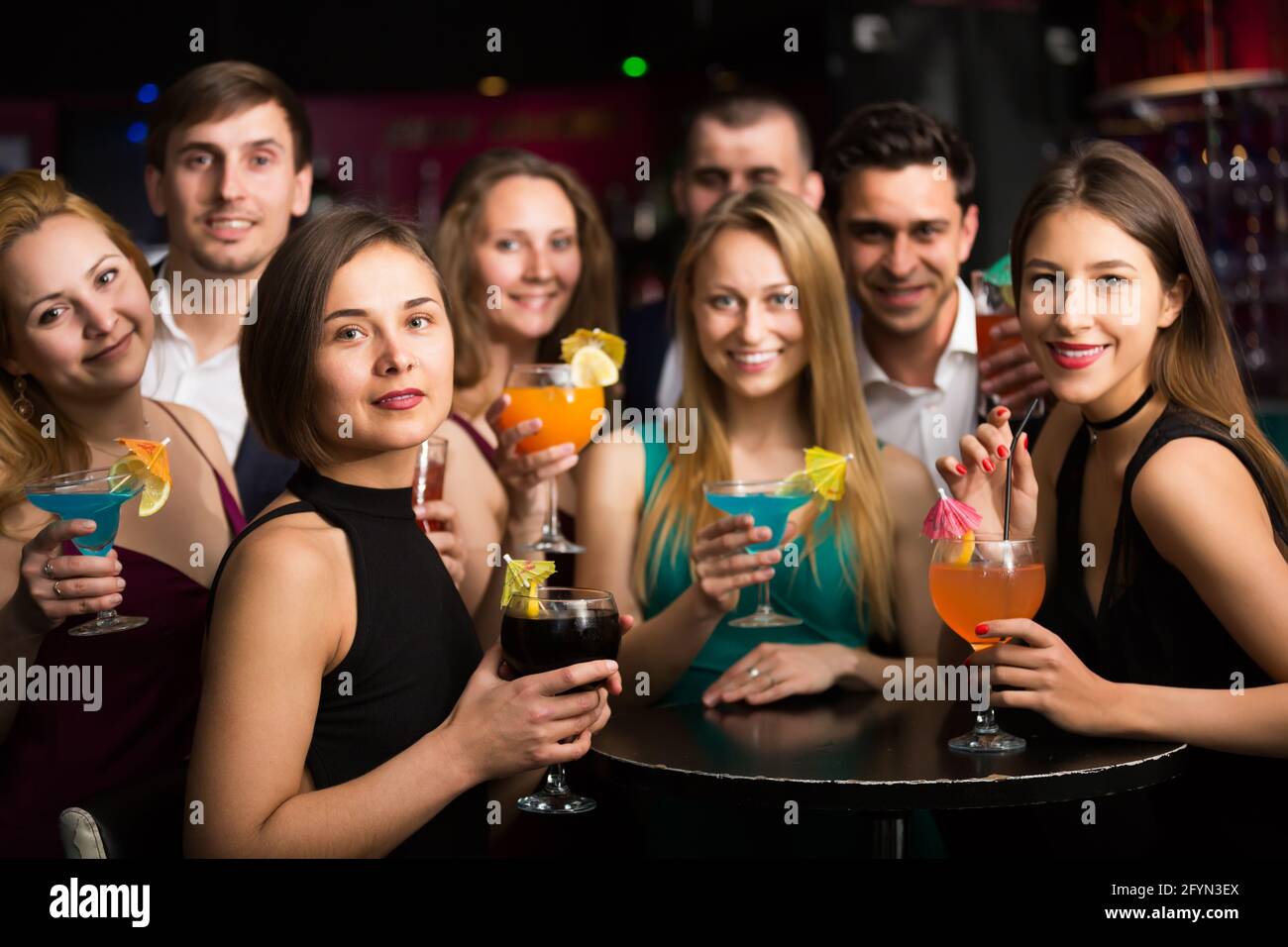 Young colleagues dancing on corporate party with alcohol in hands Stock ...