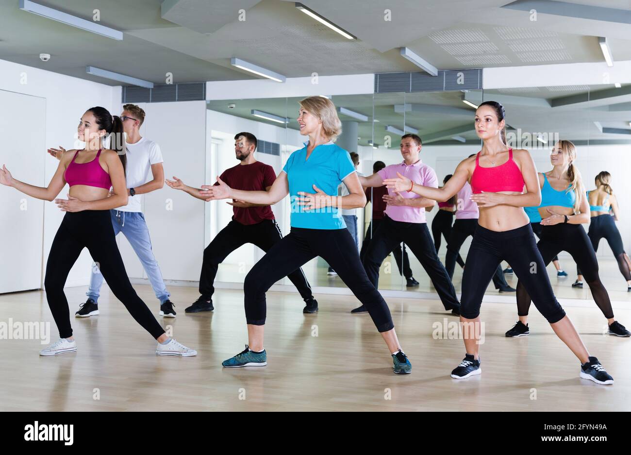 Positive people of different ages dancing in modern studio Stock Photo ...