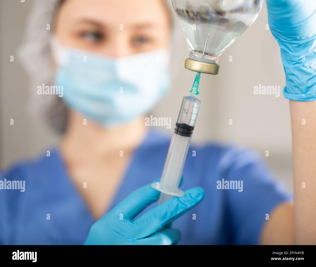 Nurse fills a syringe with injection solution Stock Photo - Alamy
