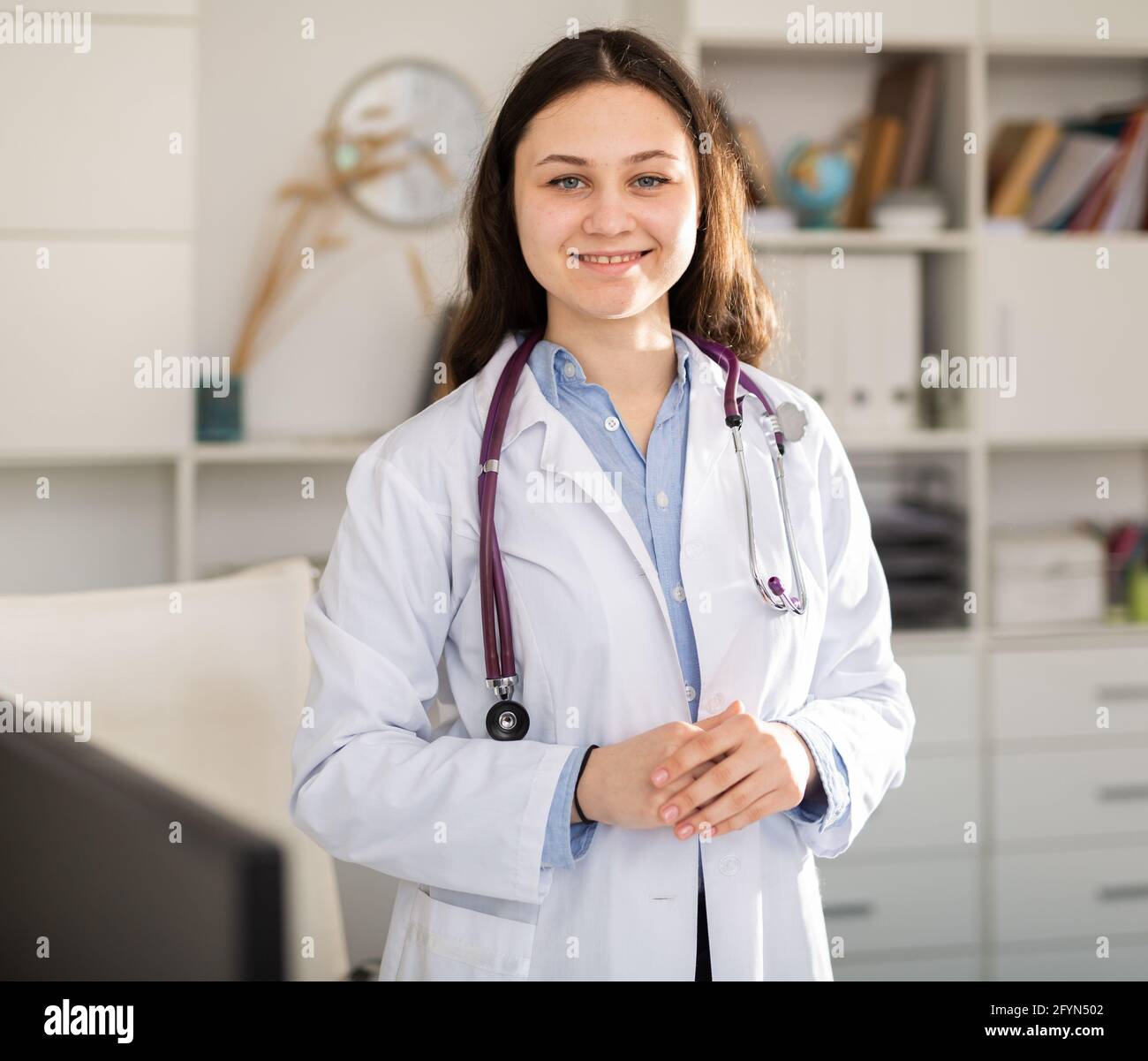 Woman doctor wear white medical uniform and stethoscope look at camera posing in private clinic ...
