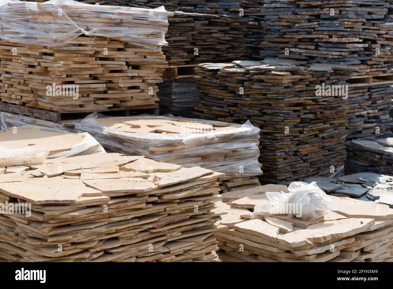 Pallets with stack of natural stone blocks lying at warehouse of ...