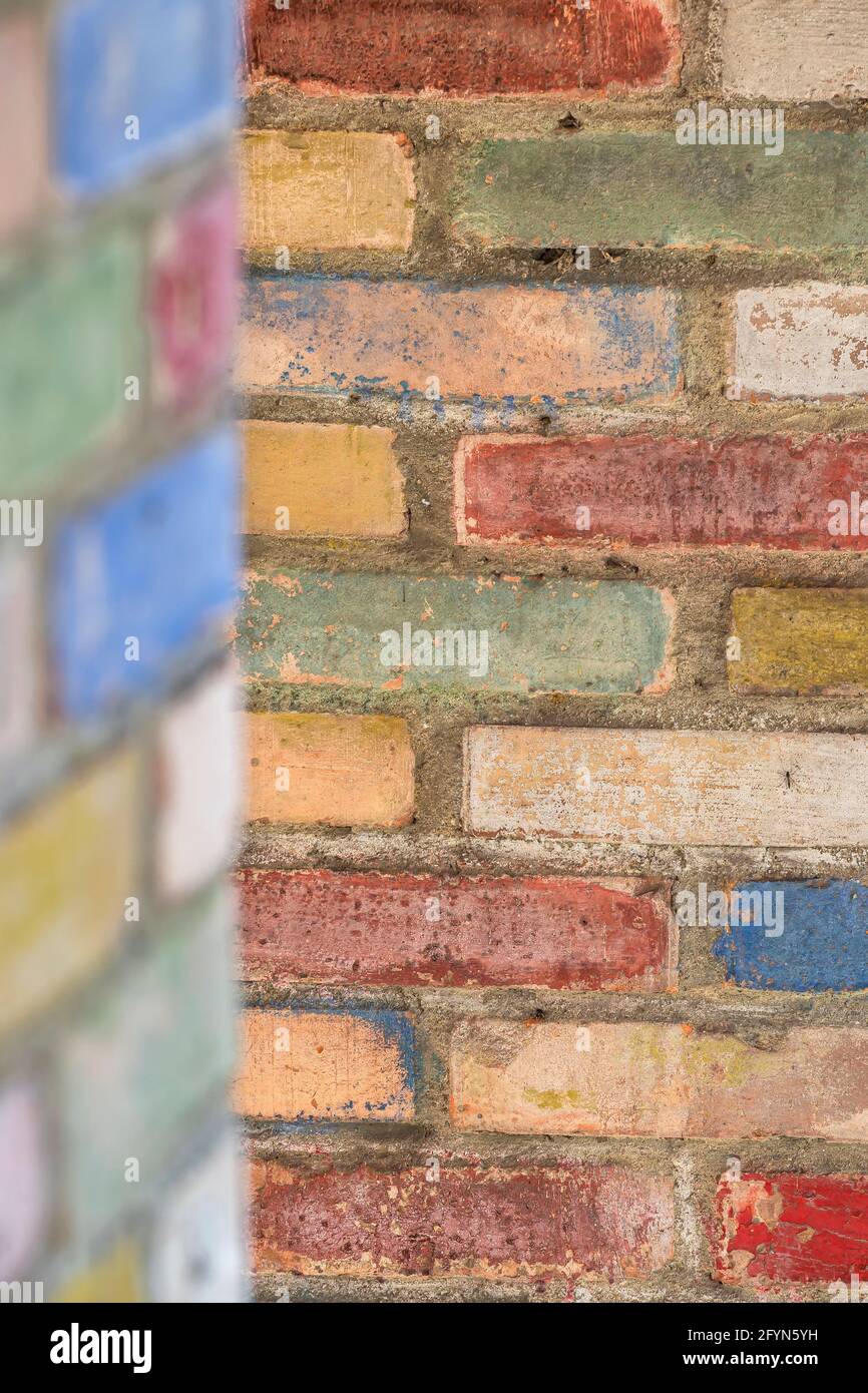 Background image of a colorful wall made of bricks in different colors ...