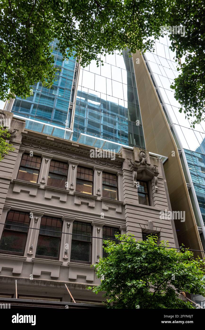 Modern skyscraper built on top of an old historic building, downtown ...