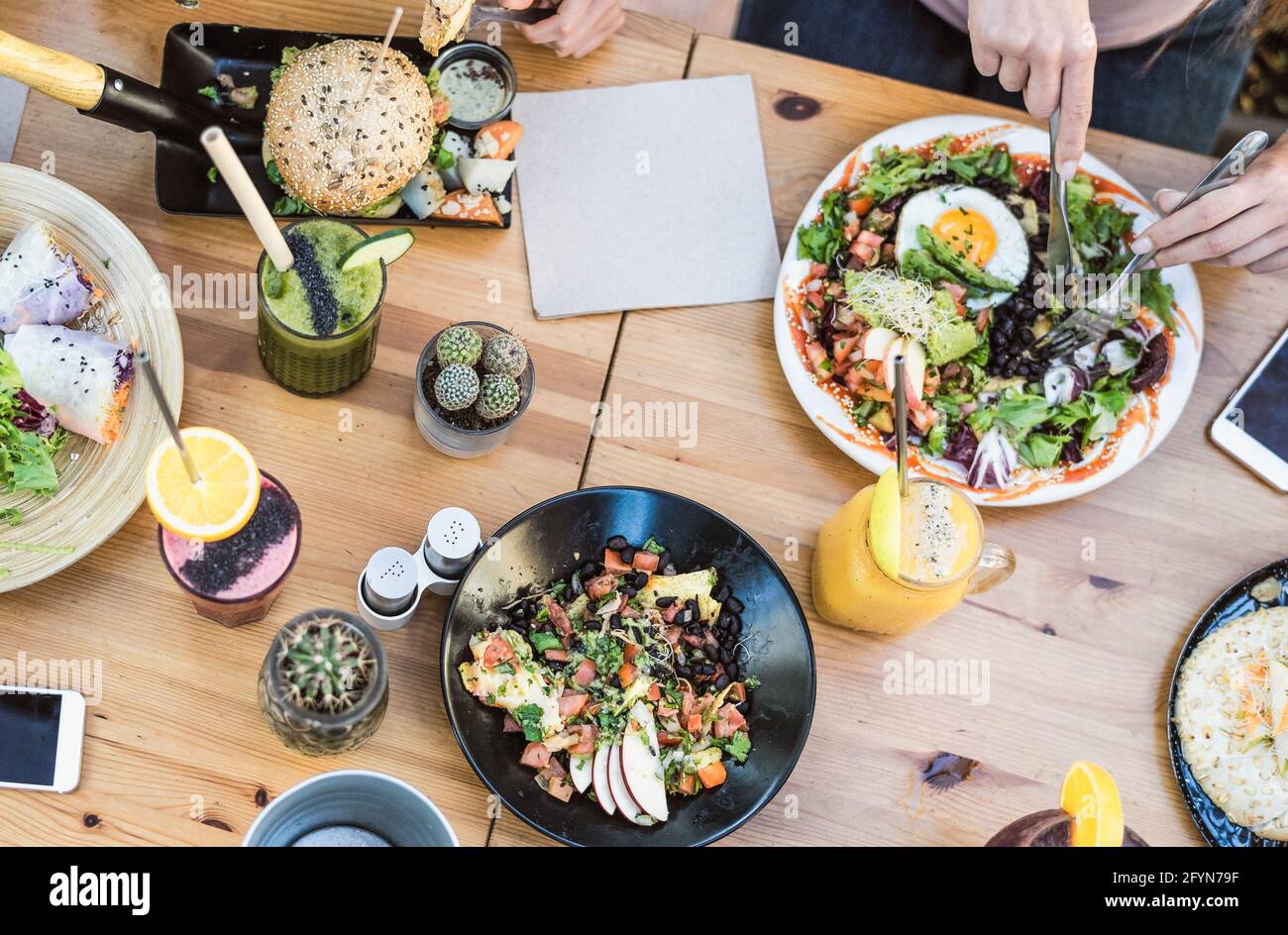 Top view of young friends eating healthy lunch in bar restaurant Stock ...