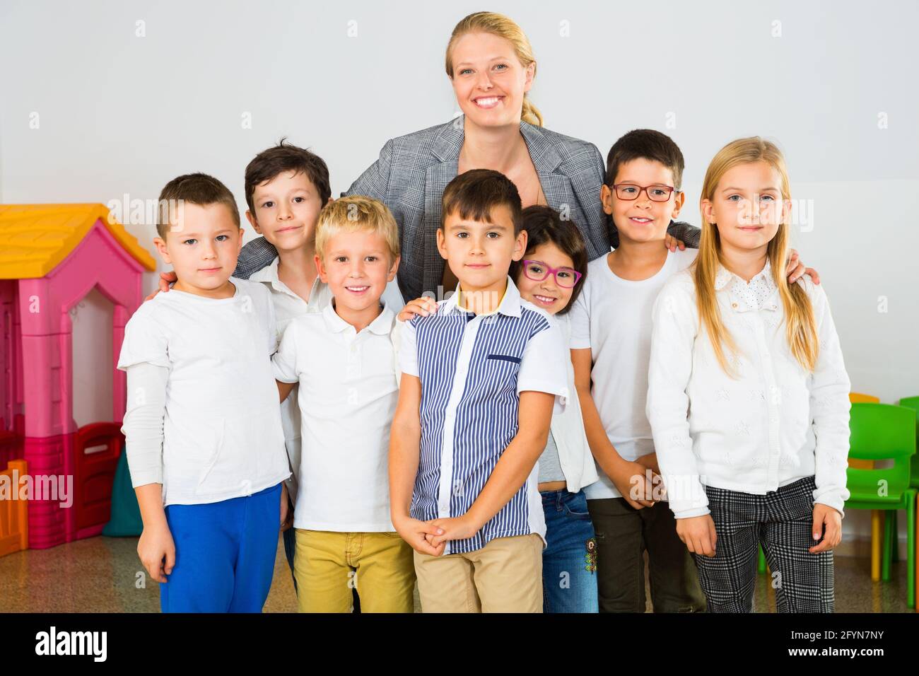 Portrait of happy positive smiling female teacher with her happy ...