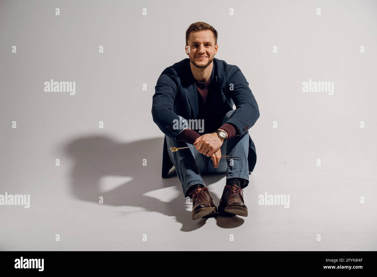 Doctor with surgical equipment needle and scissors. Handsome man weared ...