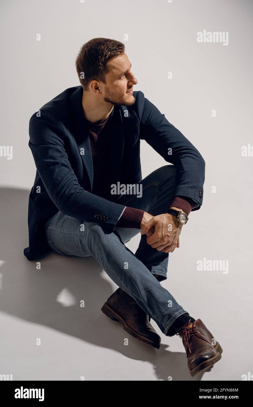 Fashion business man model posing in the studio. Confident male weared ...
