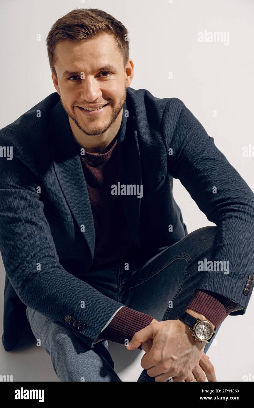 Fashion business man model posing in the studio. Confident male weared ...