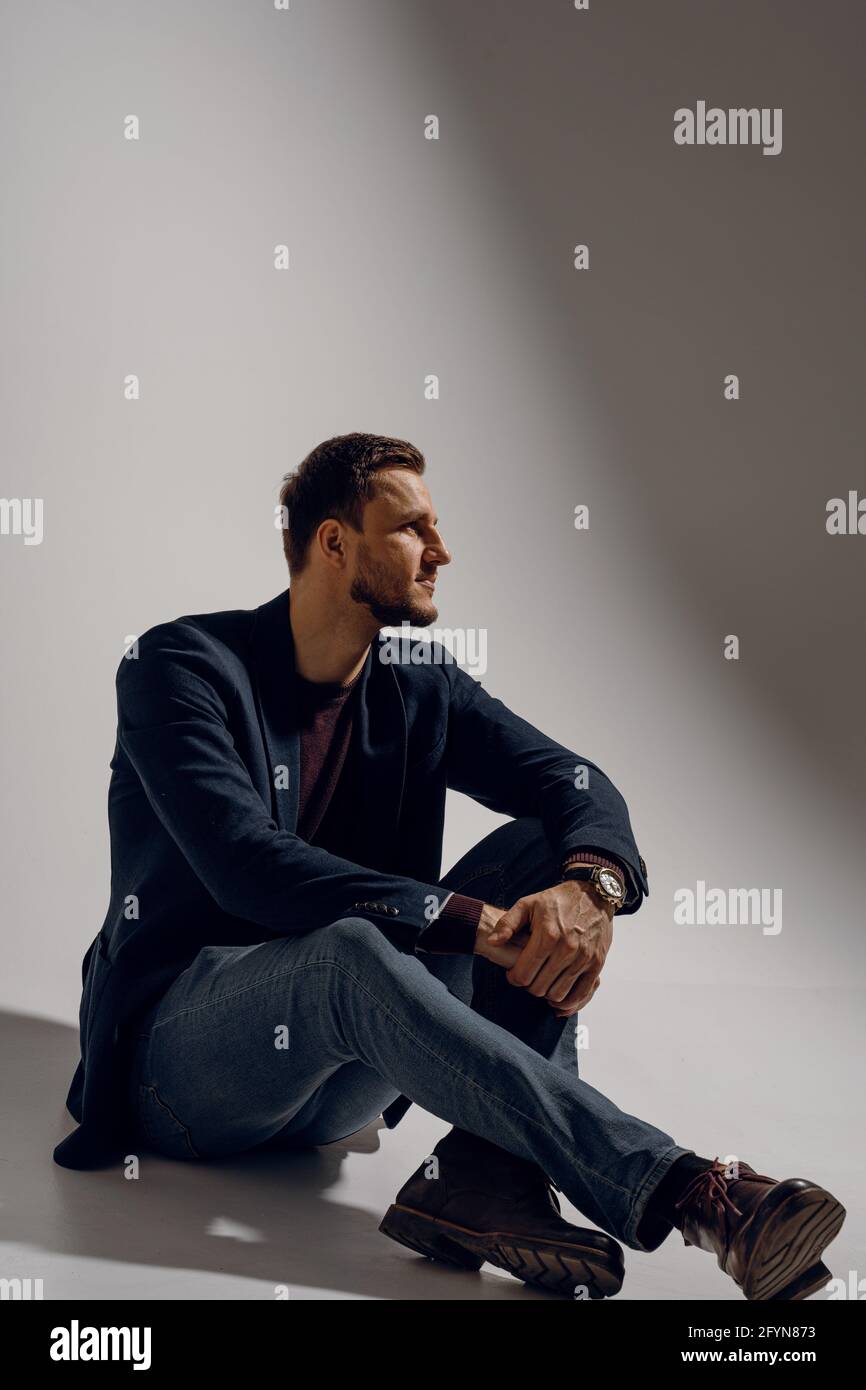 Fashion business man model posing in the studio. Confident male weared ...