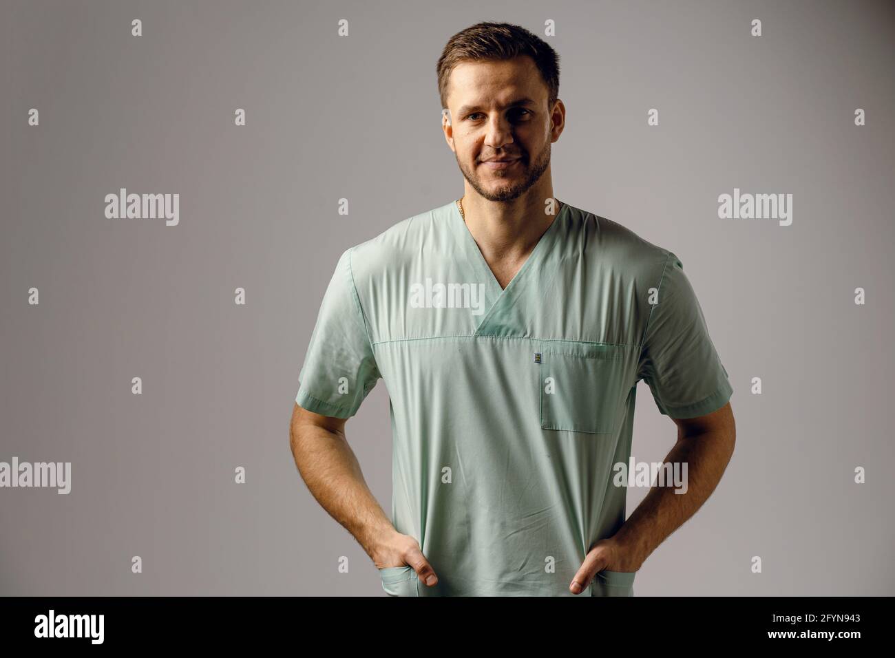 Surgeon weared in medical robe smile and posing on white background ...