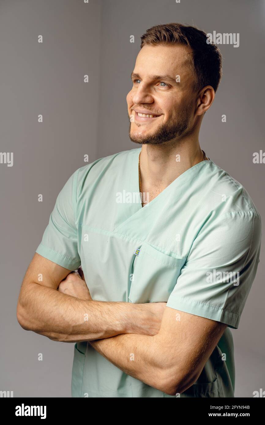 Surgeon weared in medical robe smile and posing on white background ...
