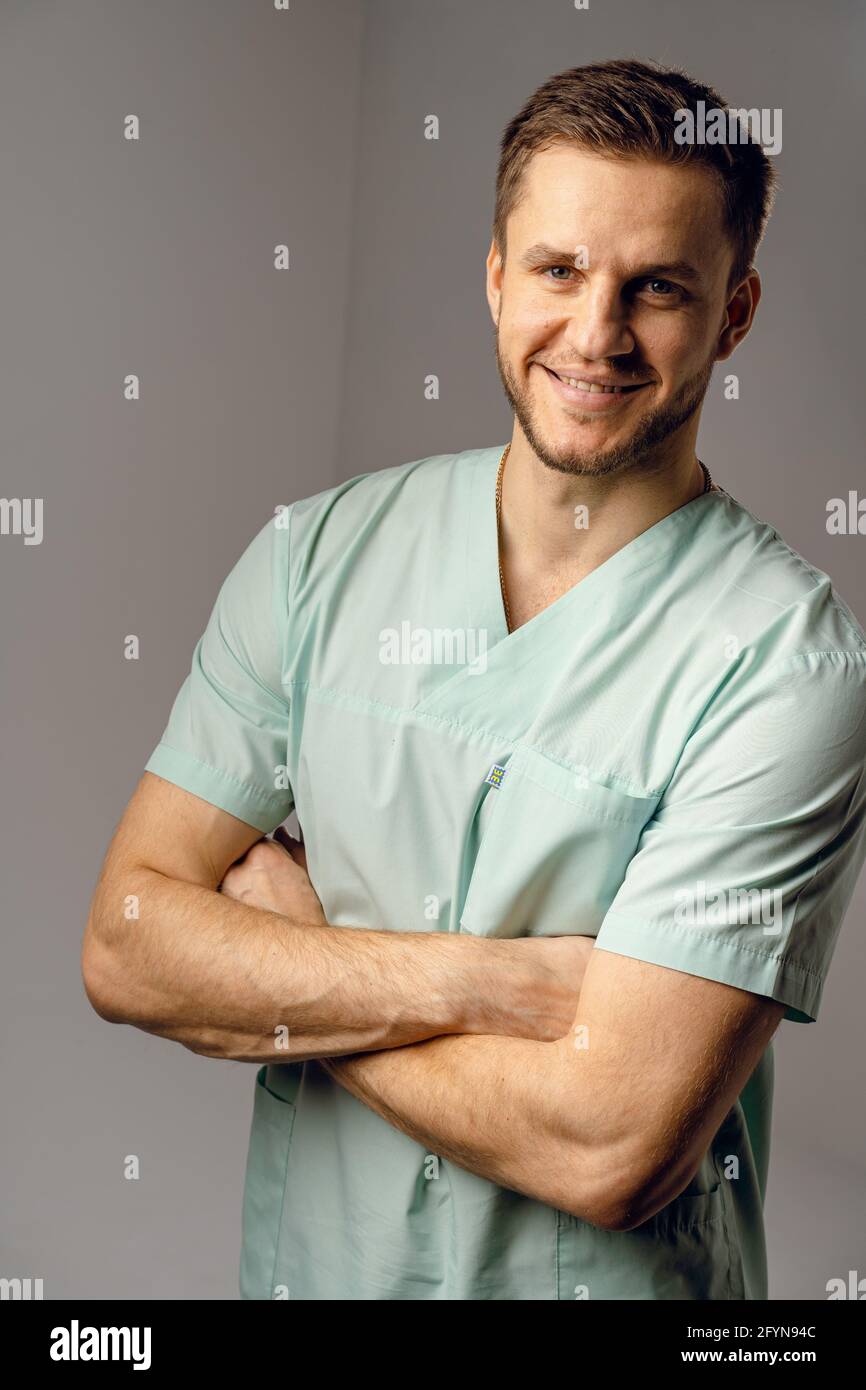 Surgeon weared in medical robe smile and posing on white background ...