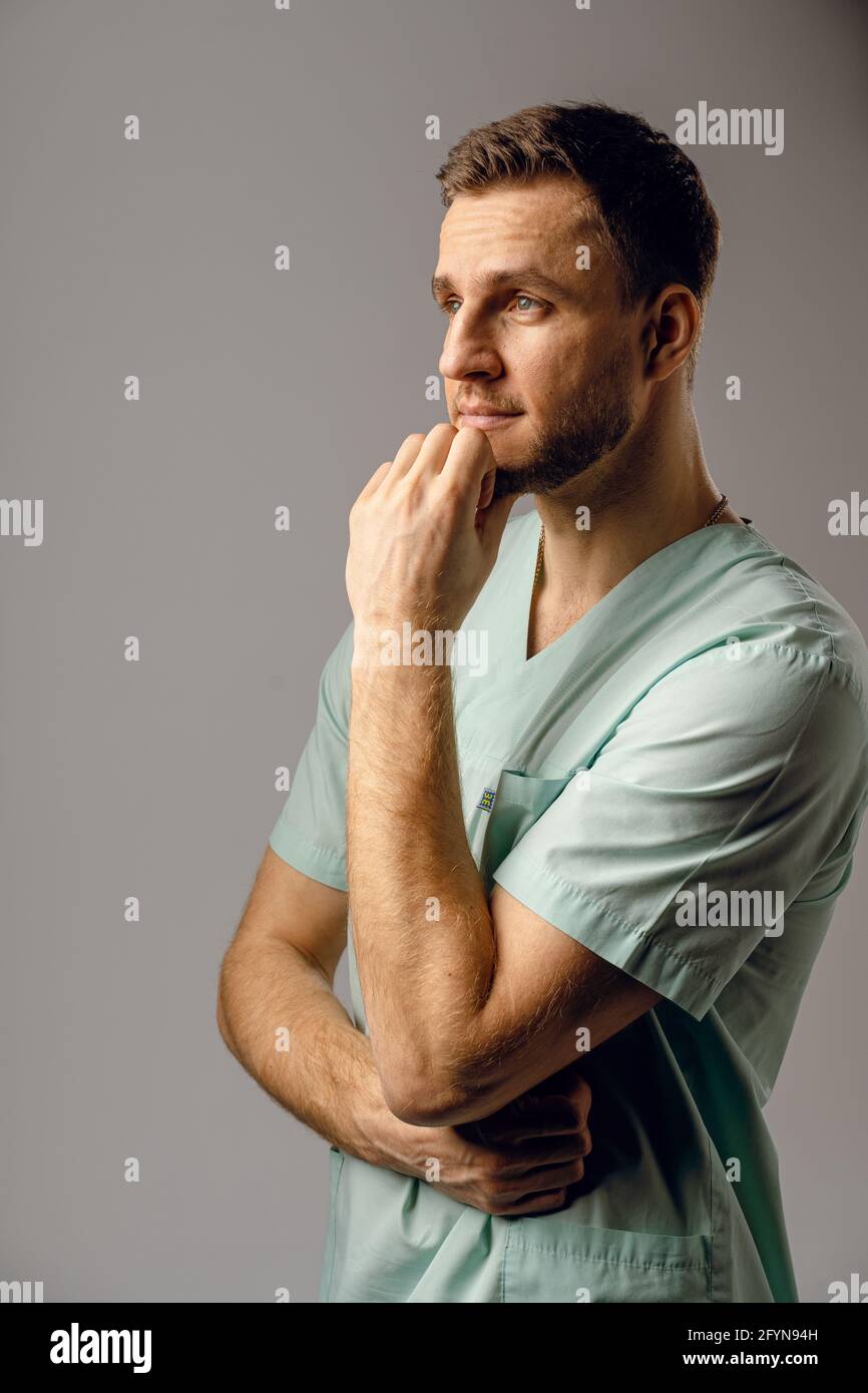 Surgeon weared in medical robe smile and posing on white background ...