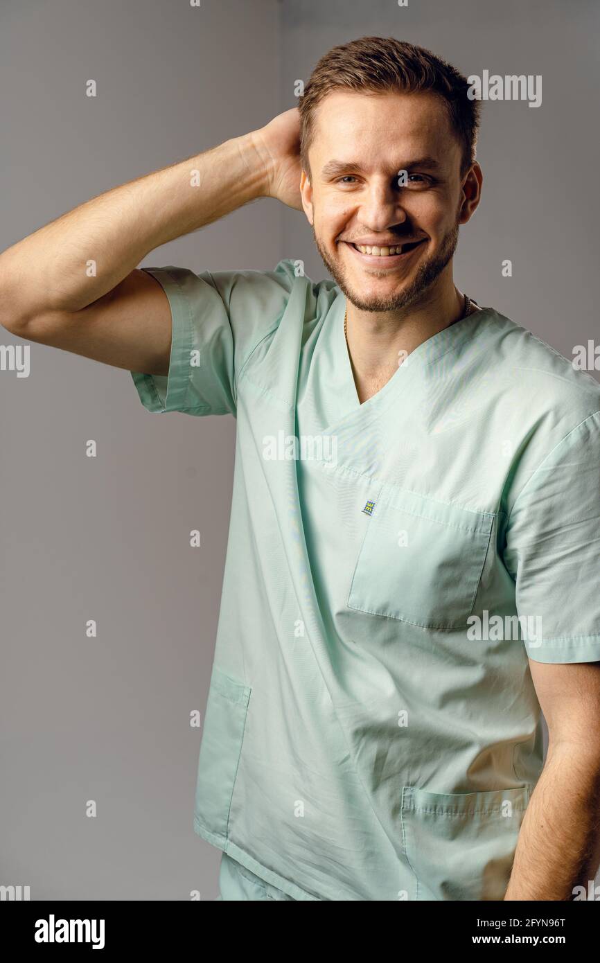 Surgeon weared in medical robe smile and posing on white background ...