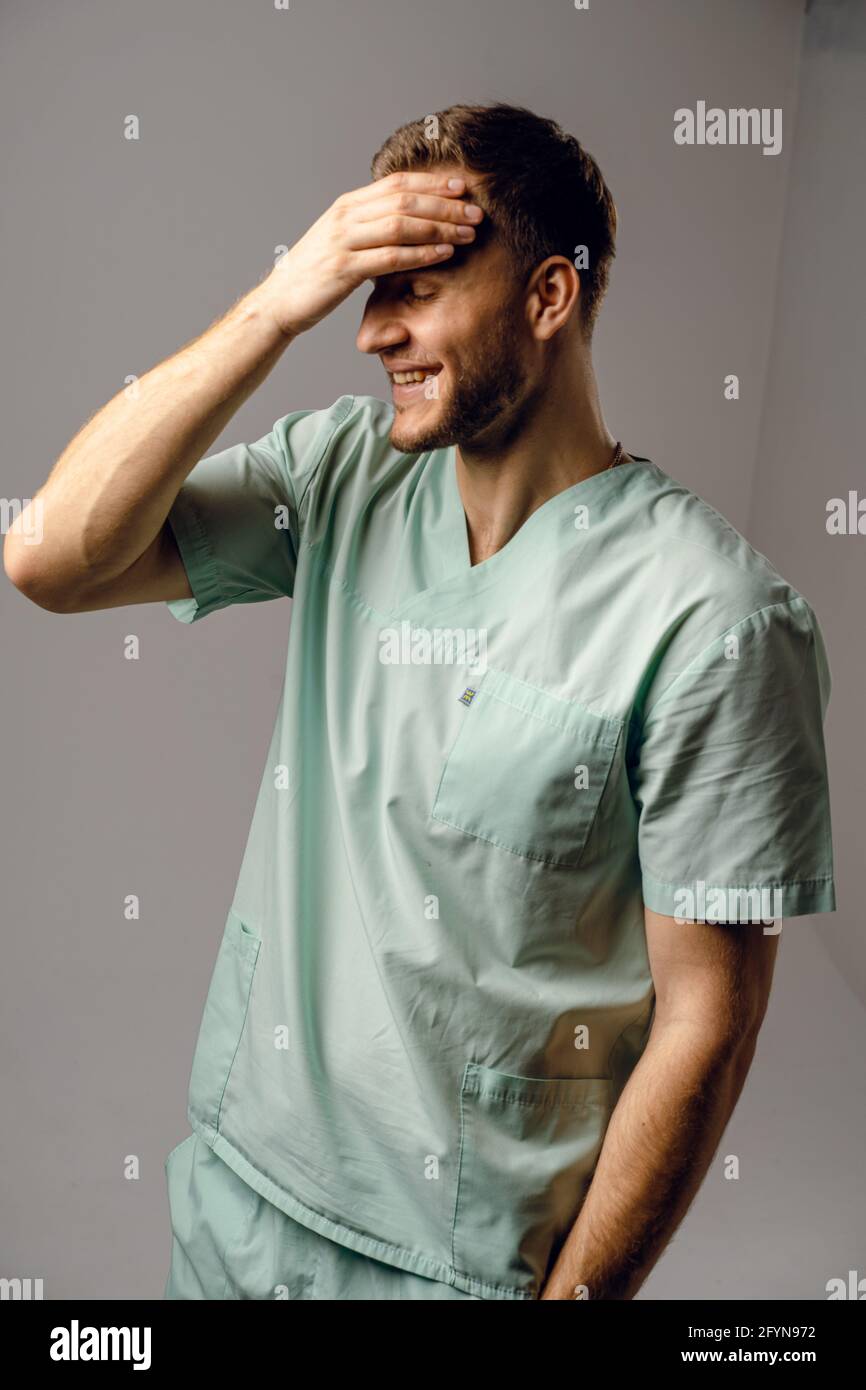Surgeon weared in medical robe smile and posing on white background ...
