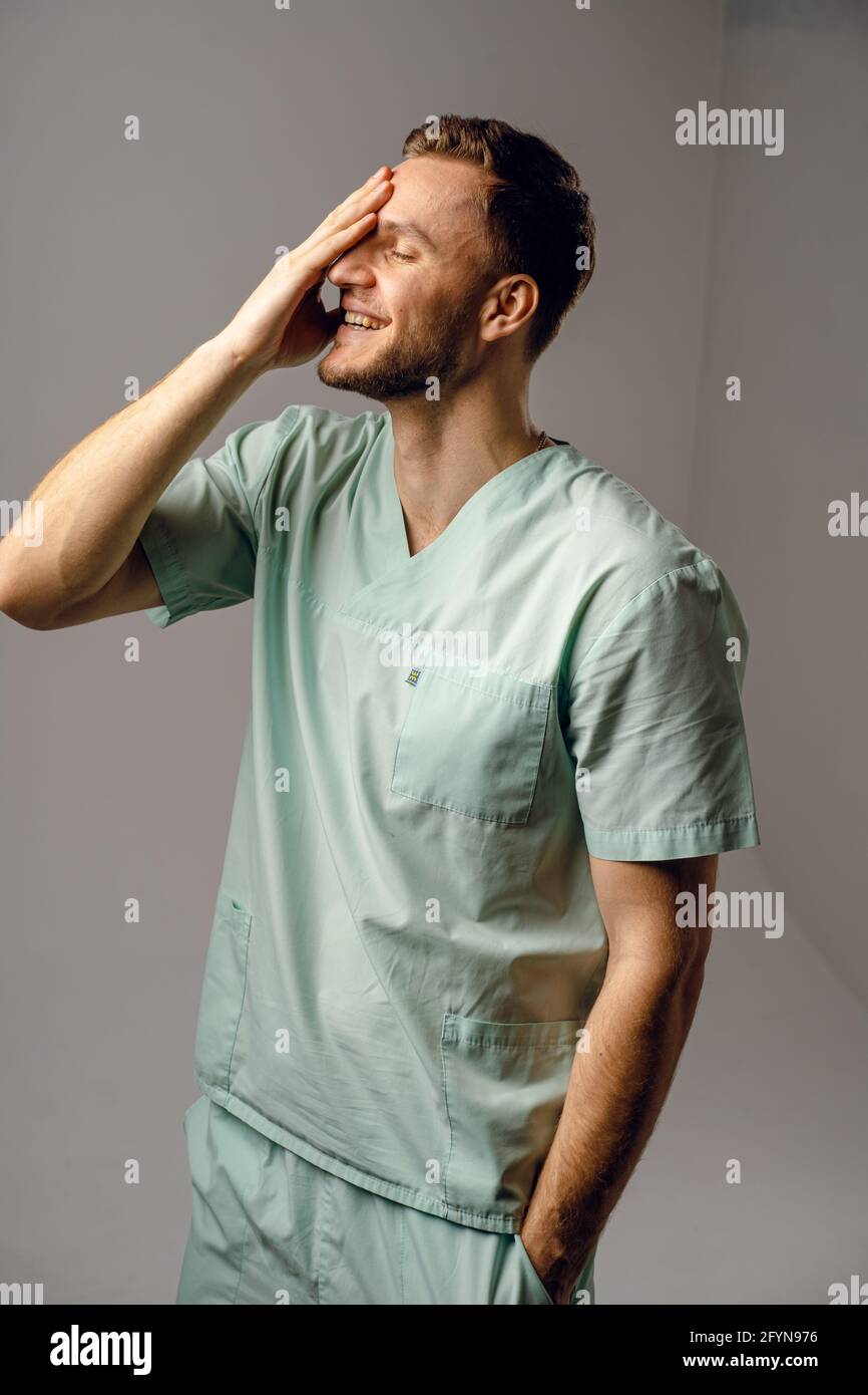 Surgeon weared in medical robe smile and posing on white background ...