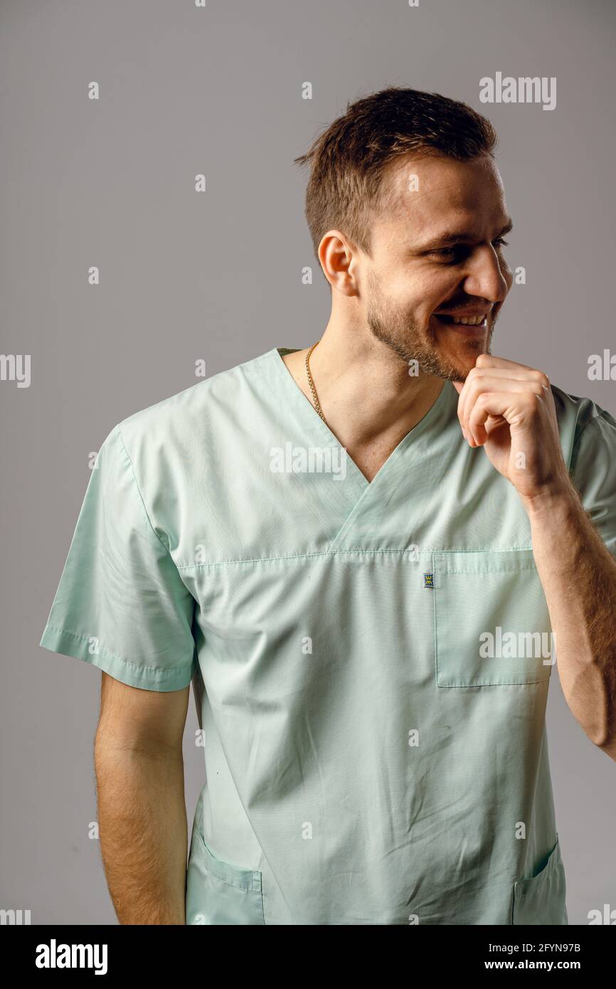 Surgeon weared in medical robe smile and posing on white background ...