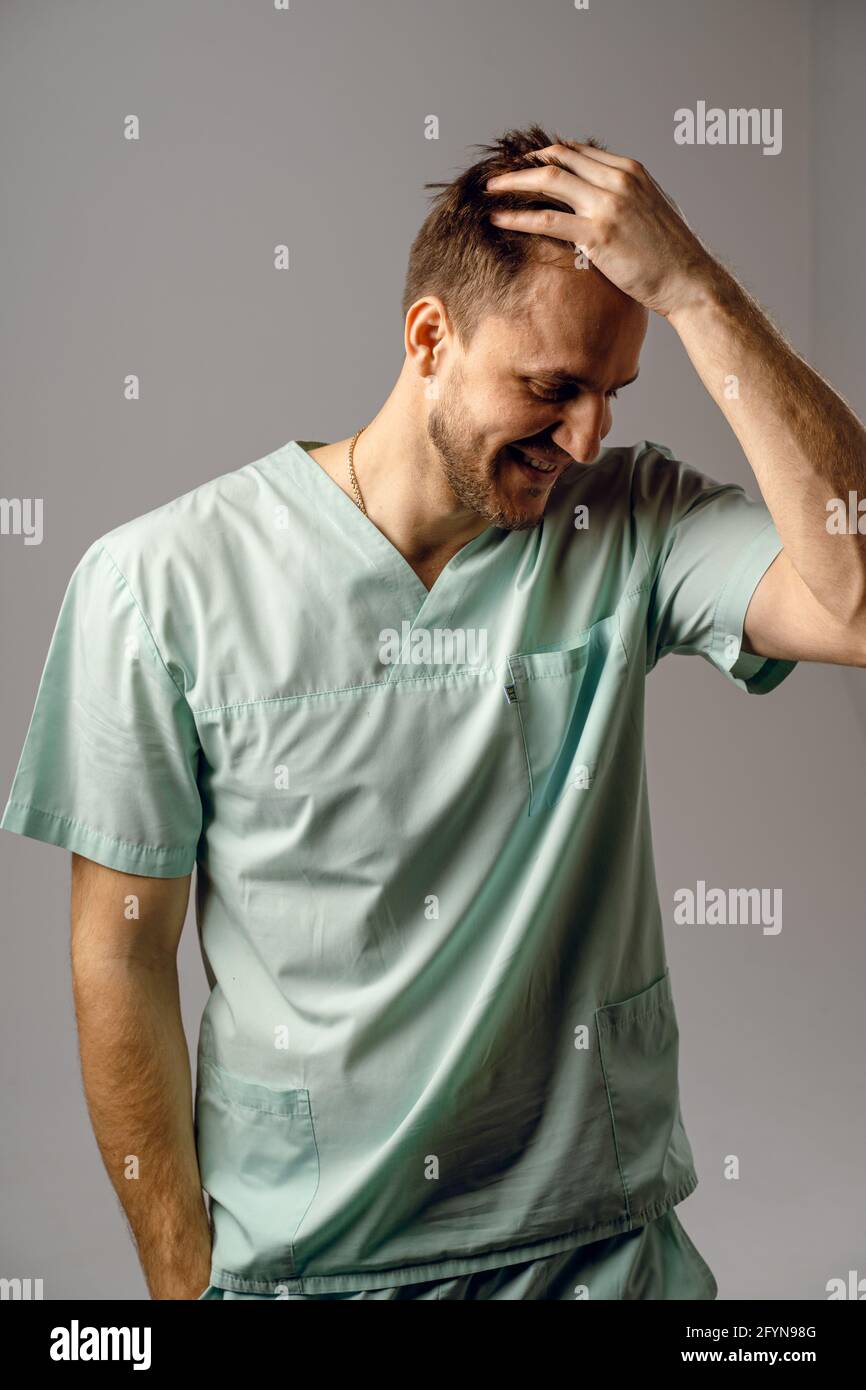 Surgeon weared in medical robe smile and posing on white background ...