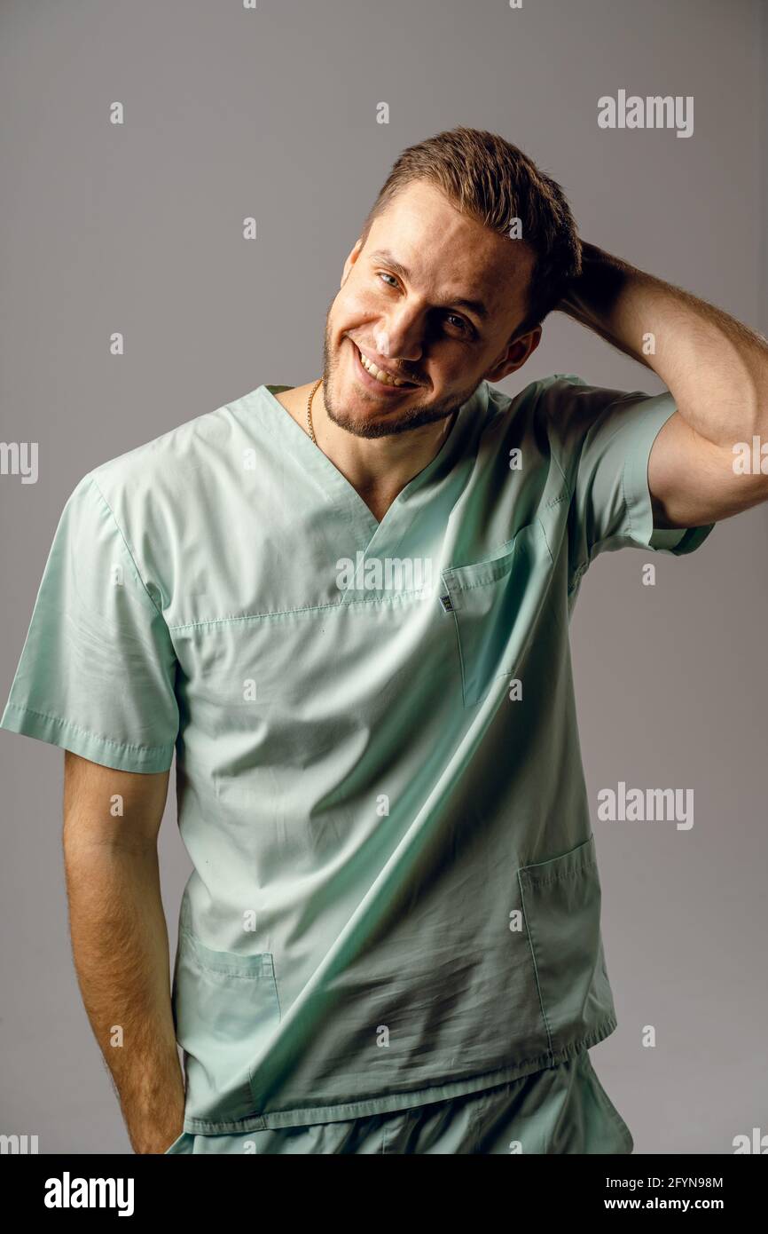 Surgeon weared in medical robe smile and posing on white background ...