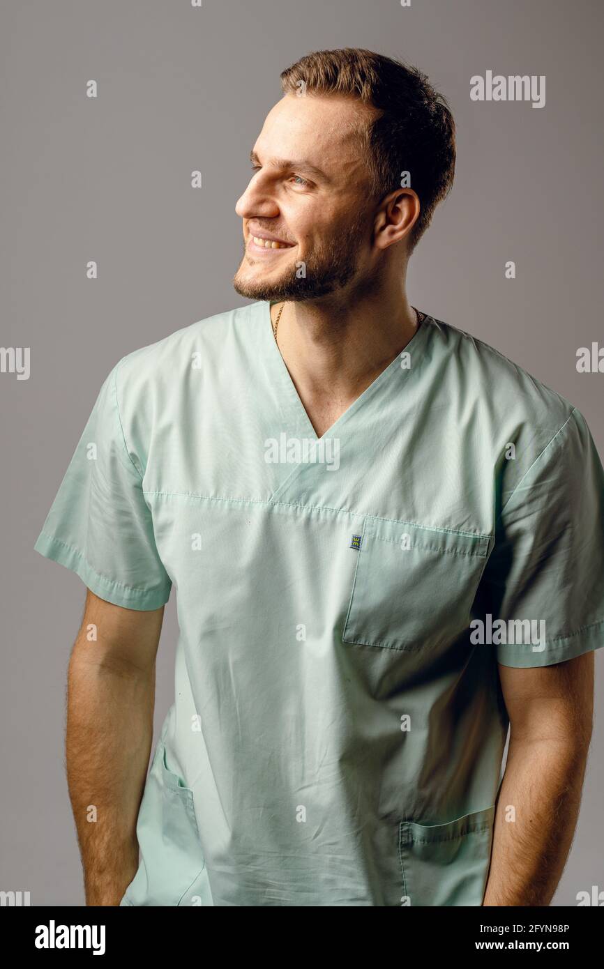 Surgeon weared in medical robe smile and posing on white background ...