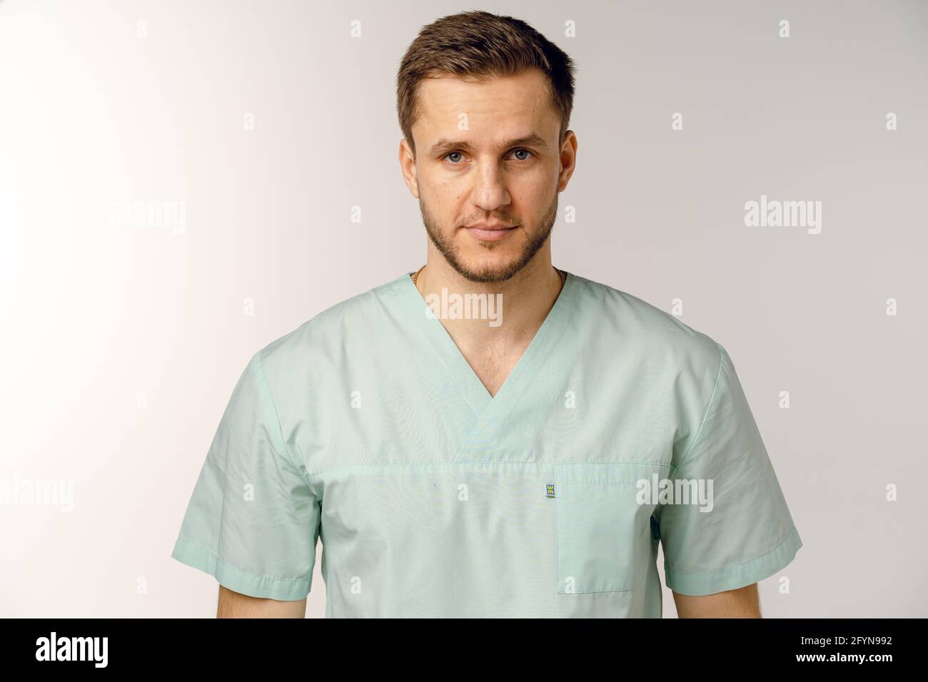 Surgeon weared in medical robe smile and posing on white background ...