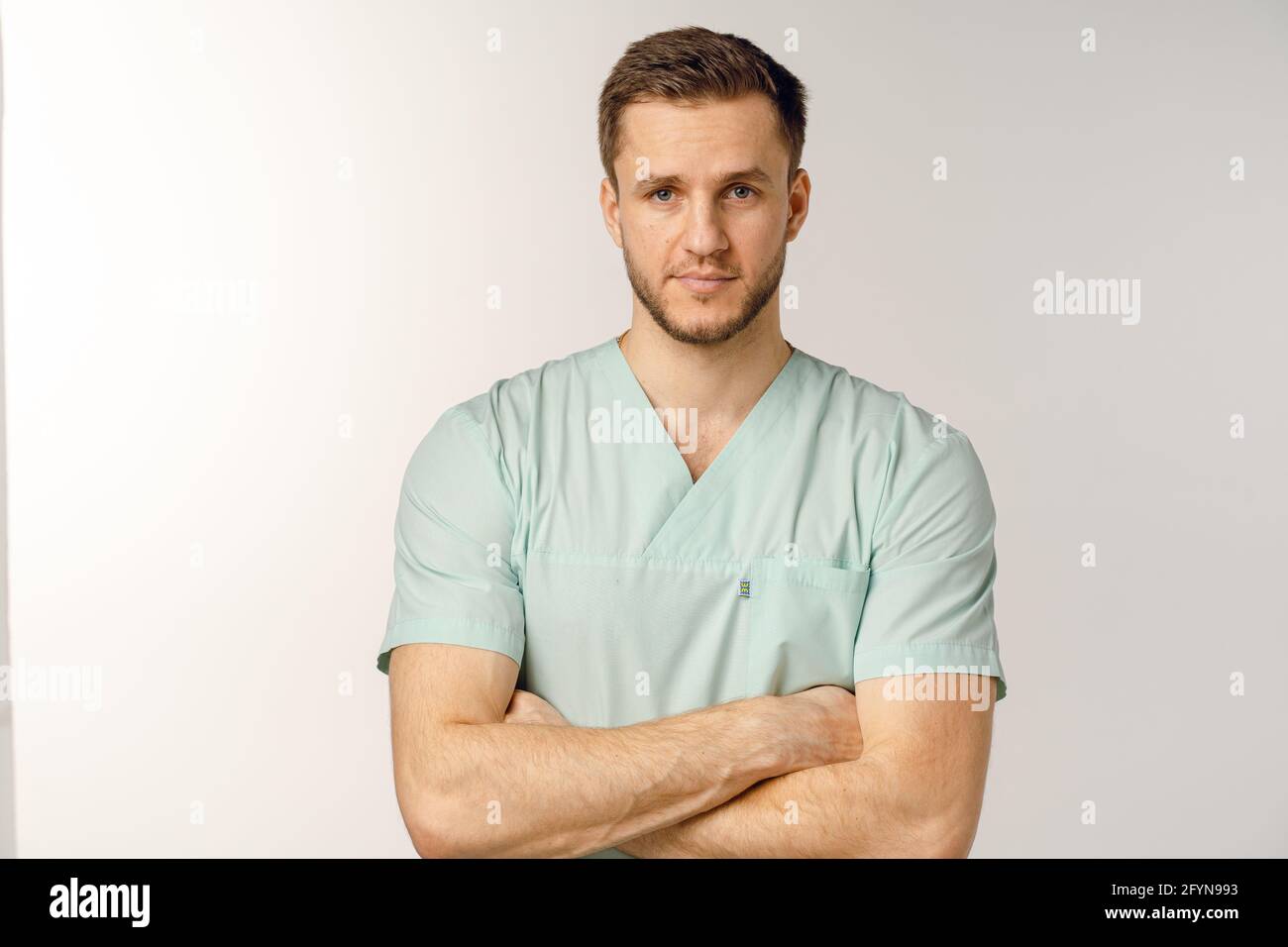 Surgeon weared in medical robe smile and posing on white background ...
