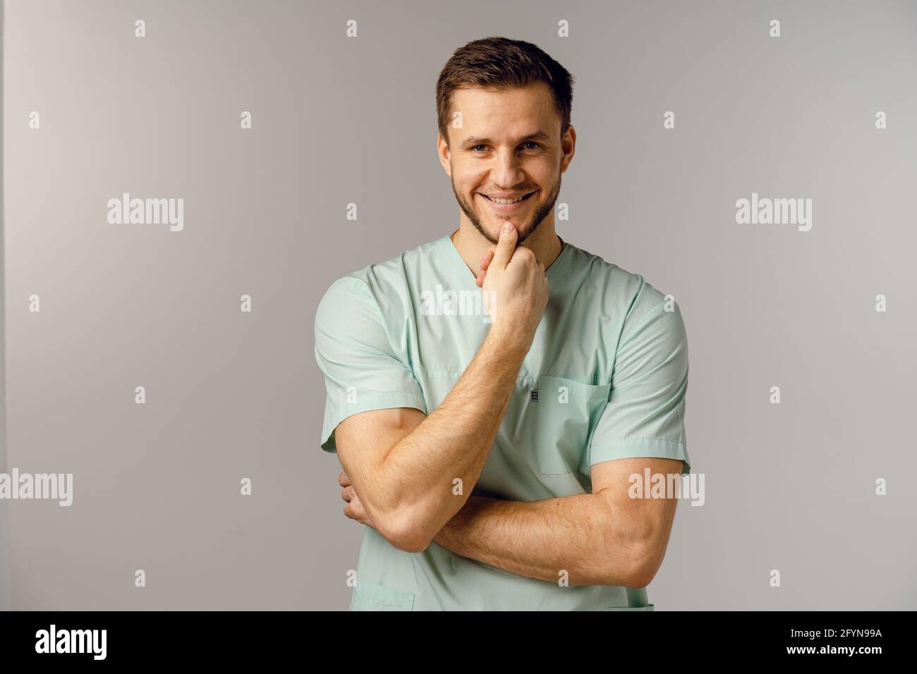 Surgeon weared in medical robe smile and posing on white background ...