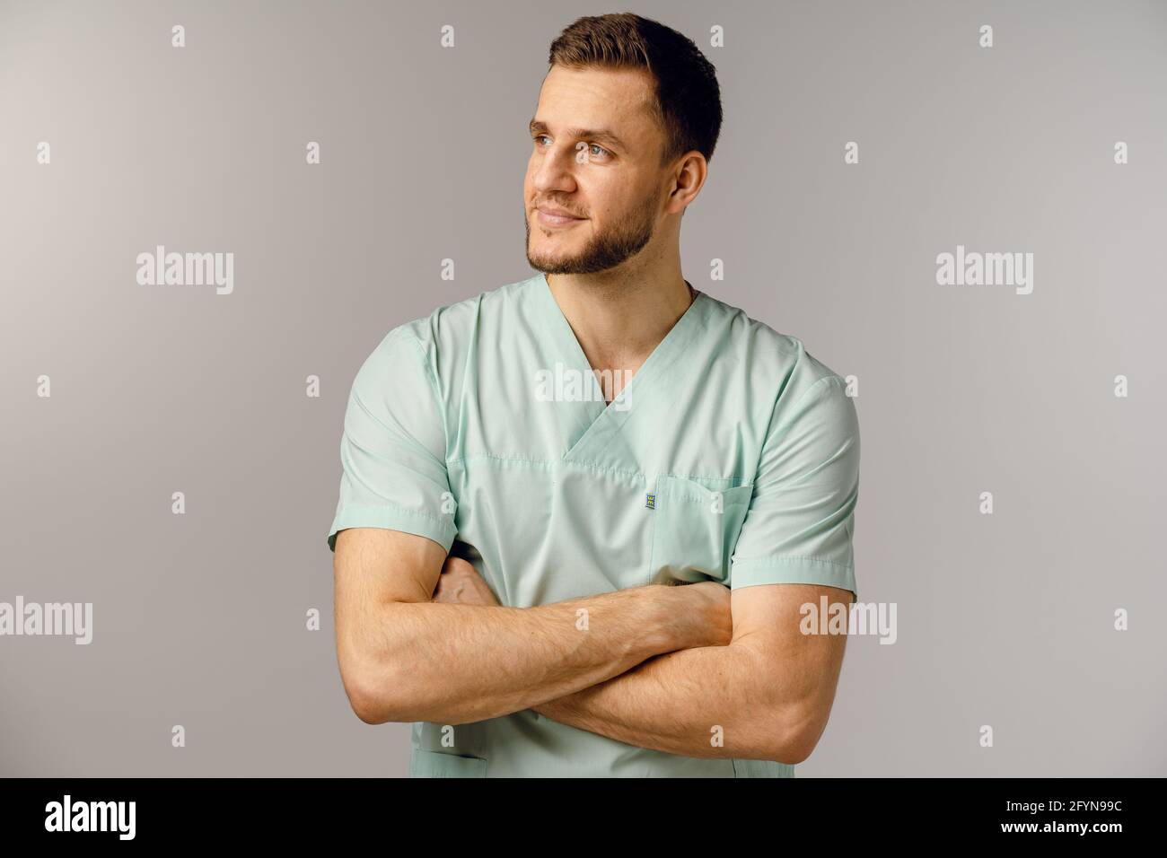 Surgeon weared in medical robe smile and posing on white background ...