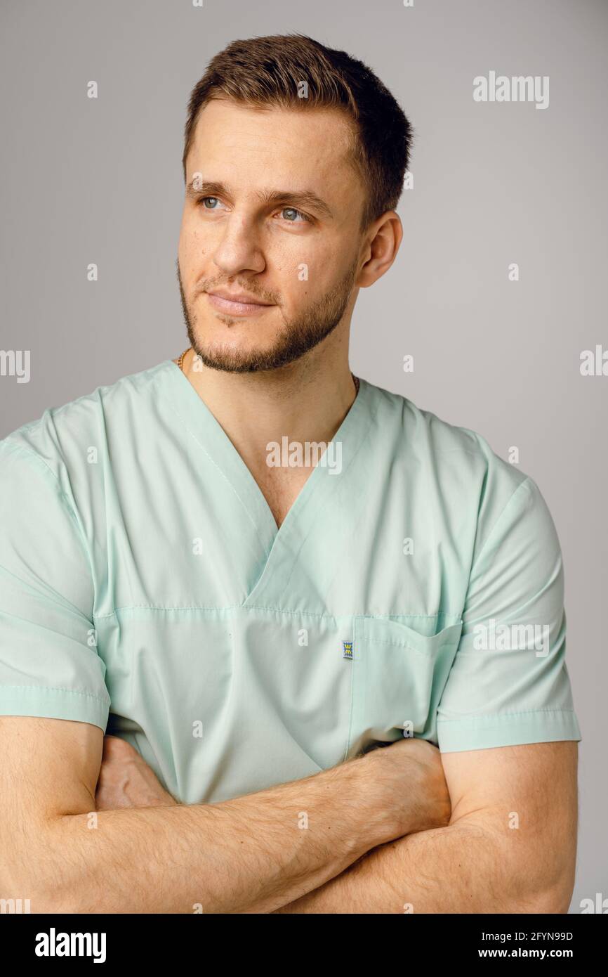 Surgeon weared in medical robe smile and posing on white background ...
