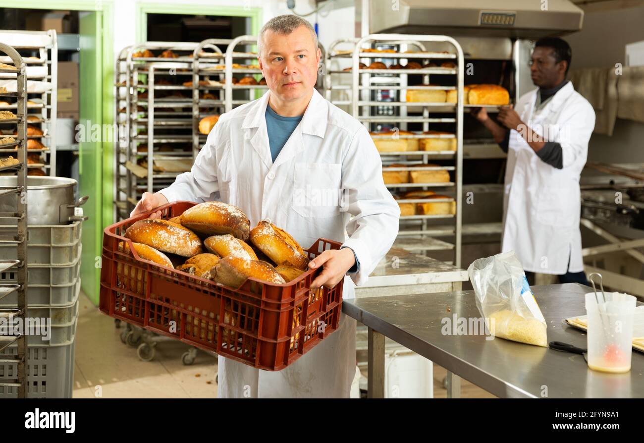 Baker sorts finished products at the bakery Stock Photo - Alamy