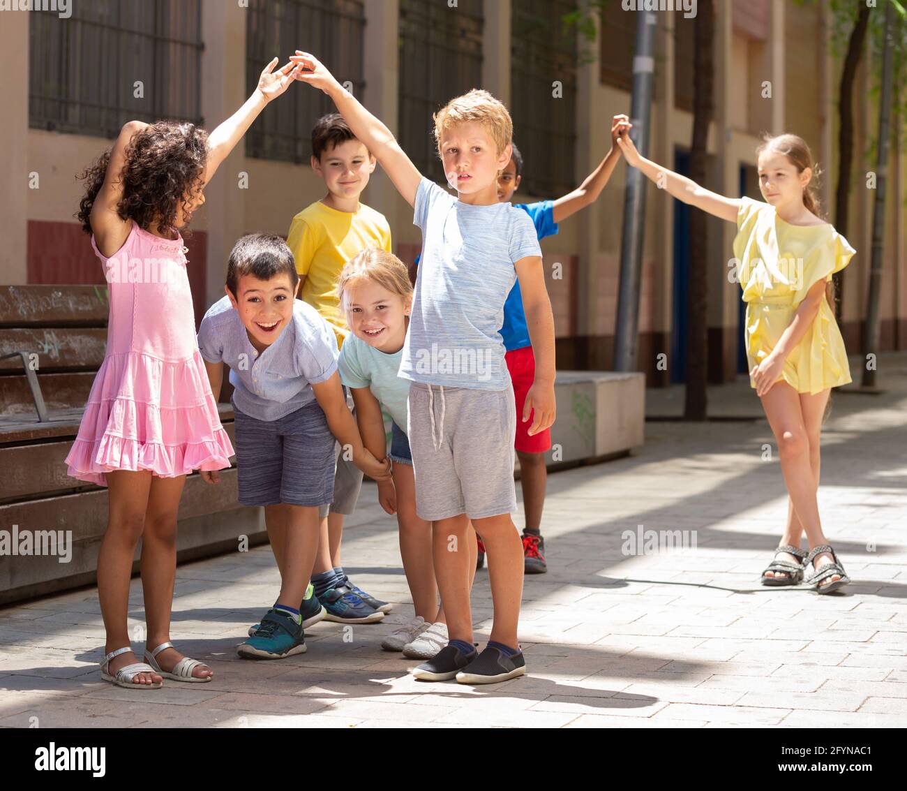 Energetic children play a game called trickle on the city street Stock ...