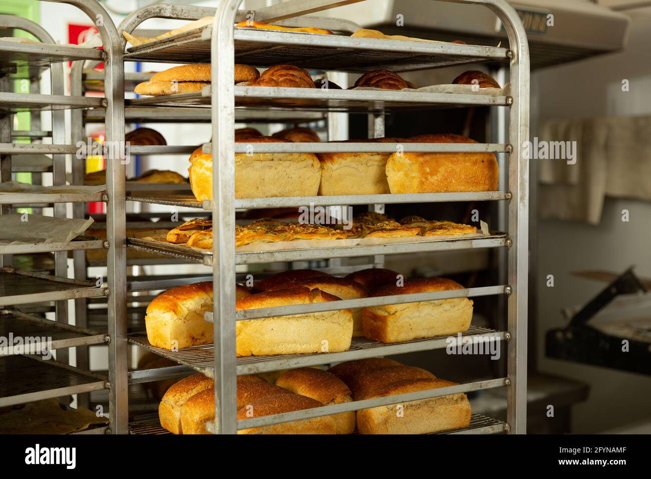 View of rack trolley with various baked bread and pastry products in ...