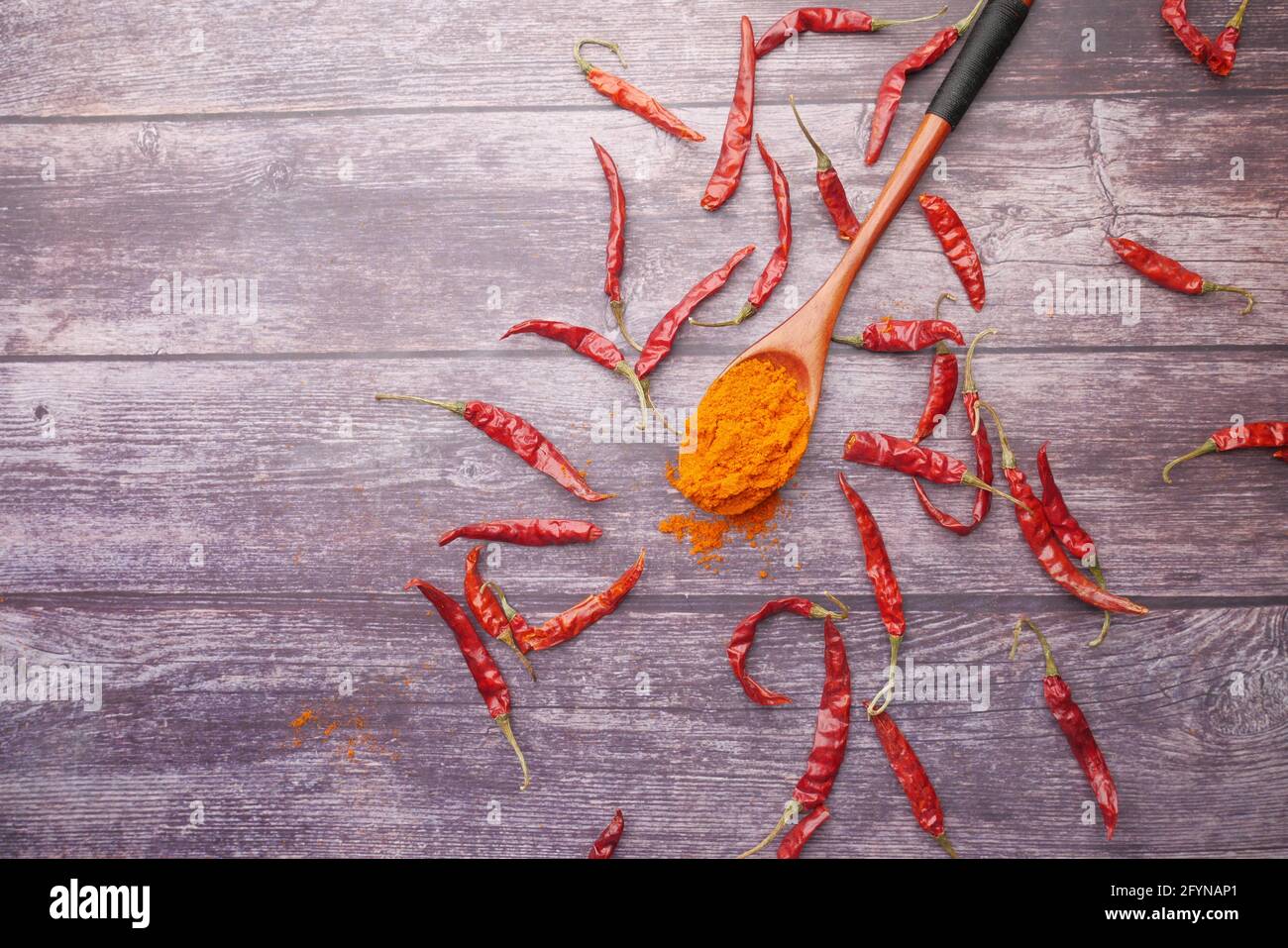 Chili powder and dried peppers on table background Stock Photo - Alamy