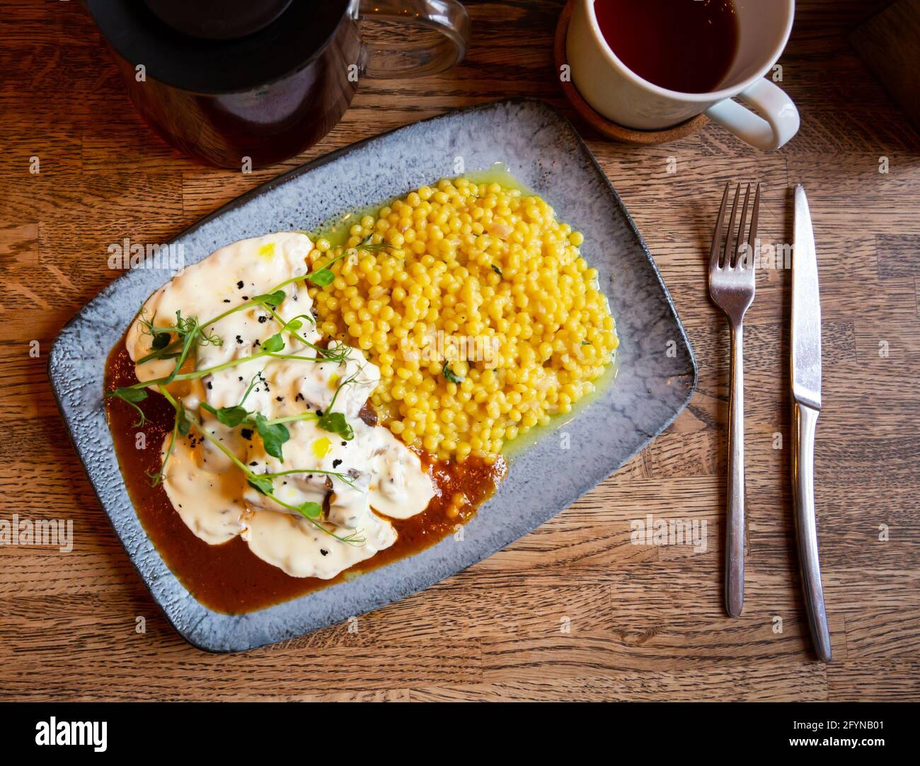 Beef cheeks with creamy mushroom sauce with ptitim pasta Stock Photo ...