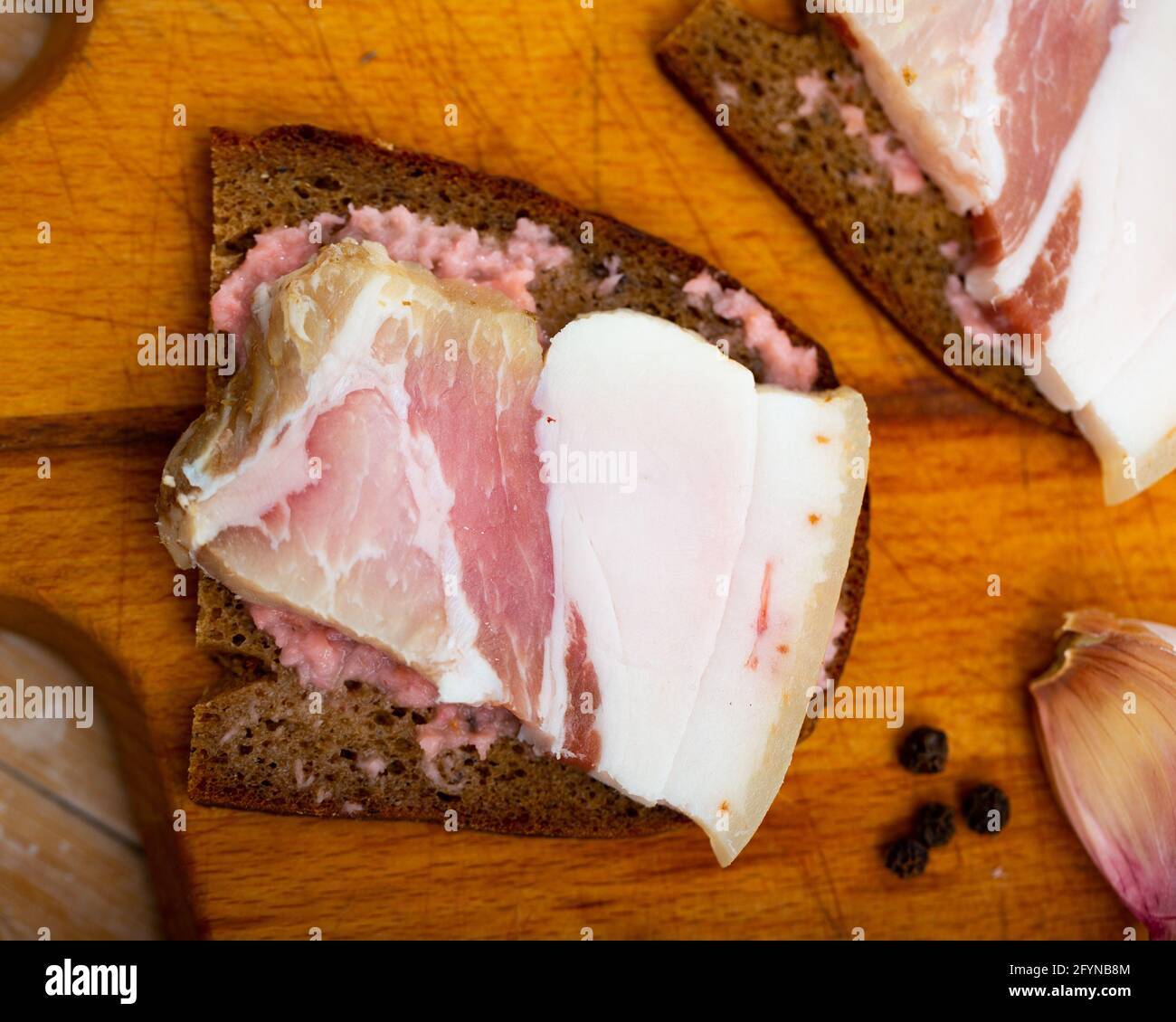 Snack for vodka, homemade salo with bread and horseradish on the rustic ...