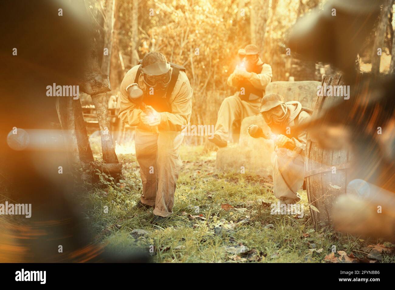 Group of people in full gear playing paintball on shooting range Stock ...