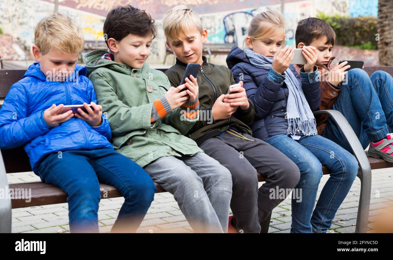 Children playing on smartphone outdoors Stock Photo - Alamy