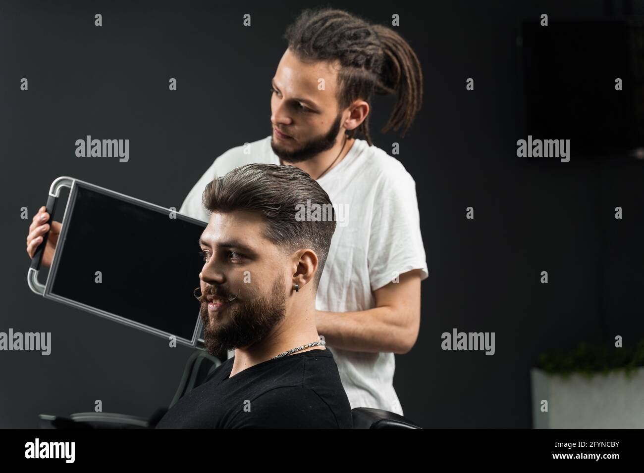 Barber with dreadlocks showing result of low fade machine hair and ...