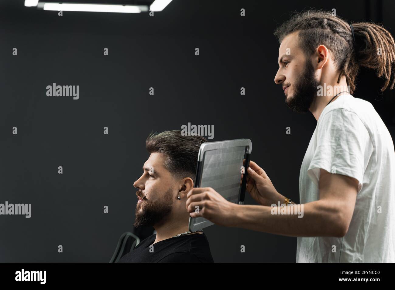 Barber with dreadlocks showing result of low fade machine hair and ...