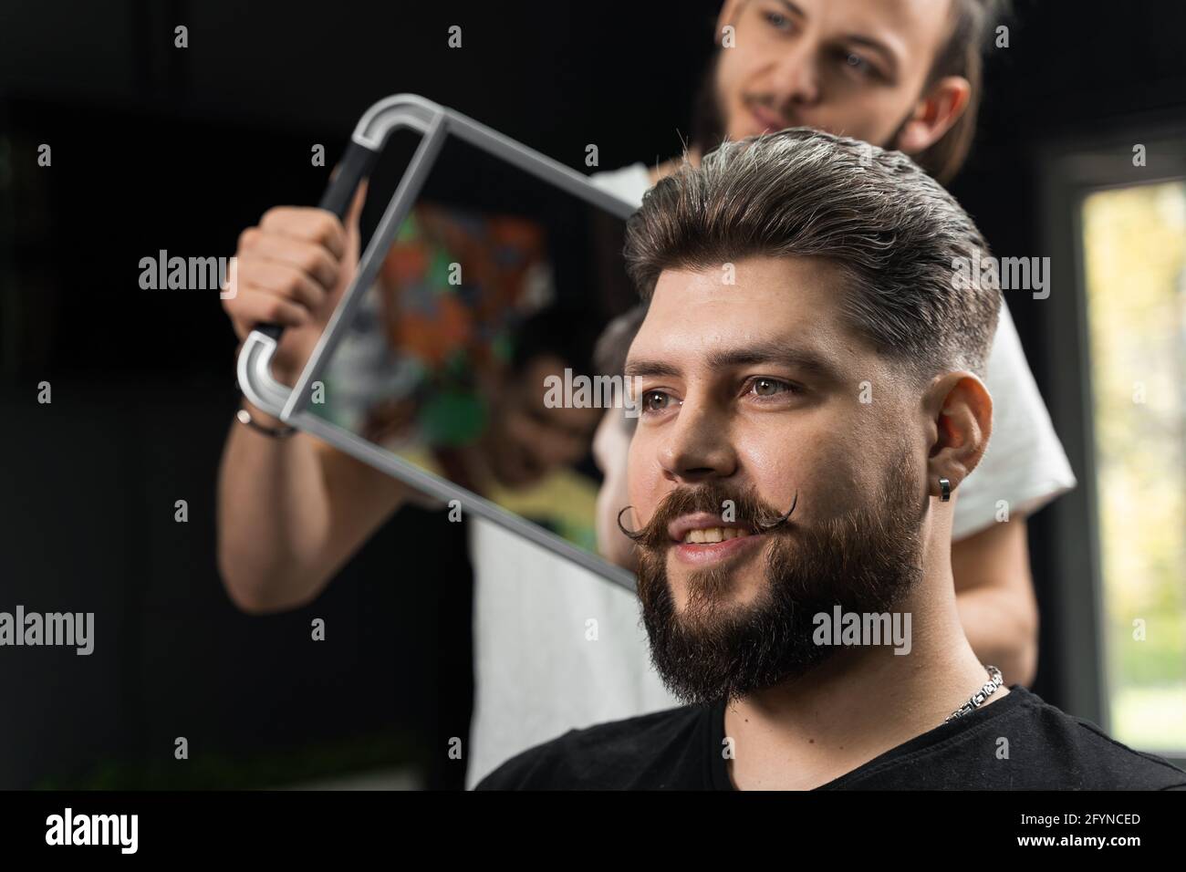 Barber with dreadlocks showing result of low fade machine hair and ...