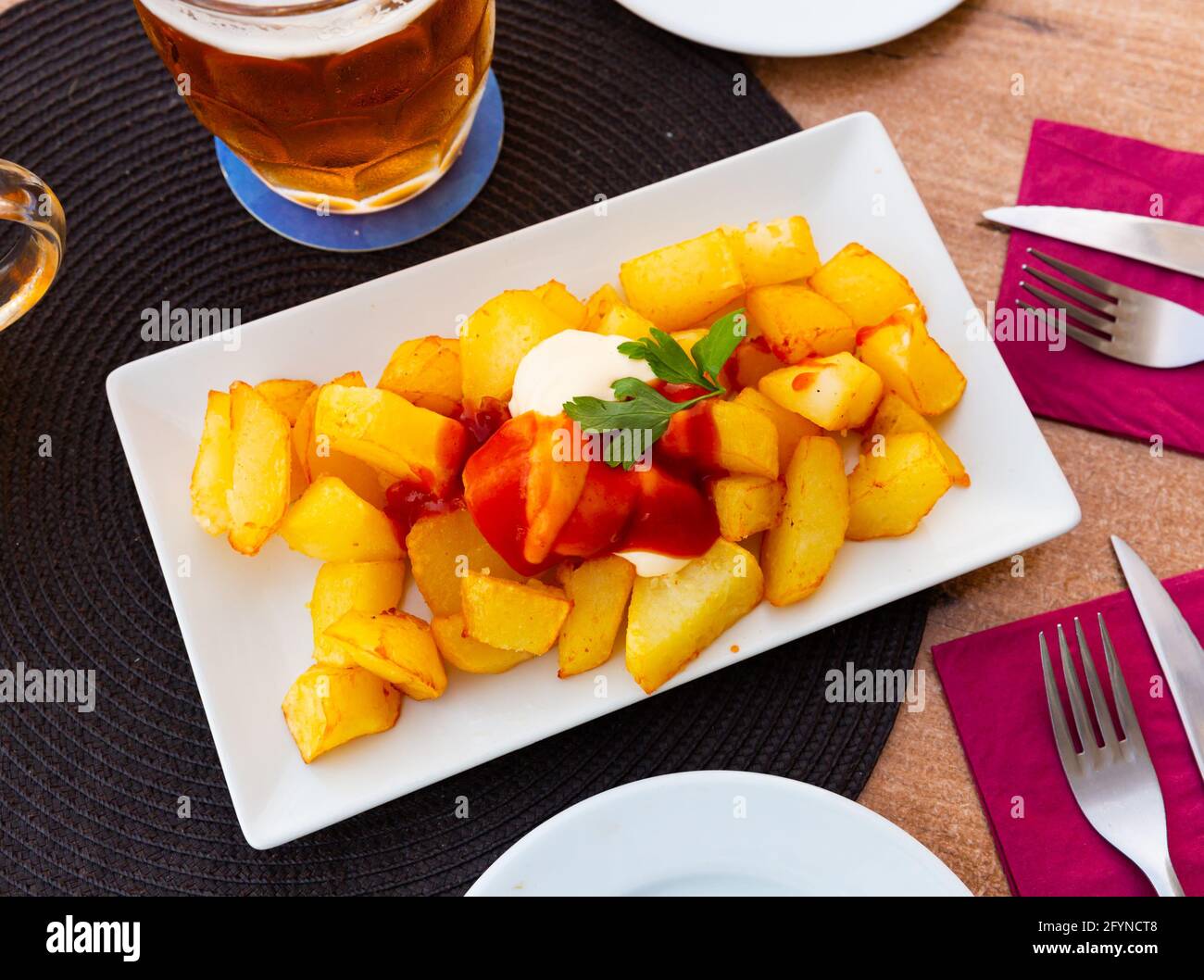 Traditional Spanish Patatas bravas, fried spicy potatoes with sauces ...