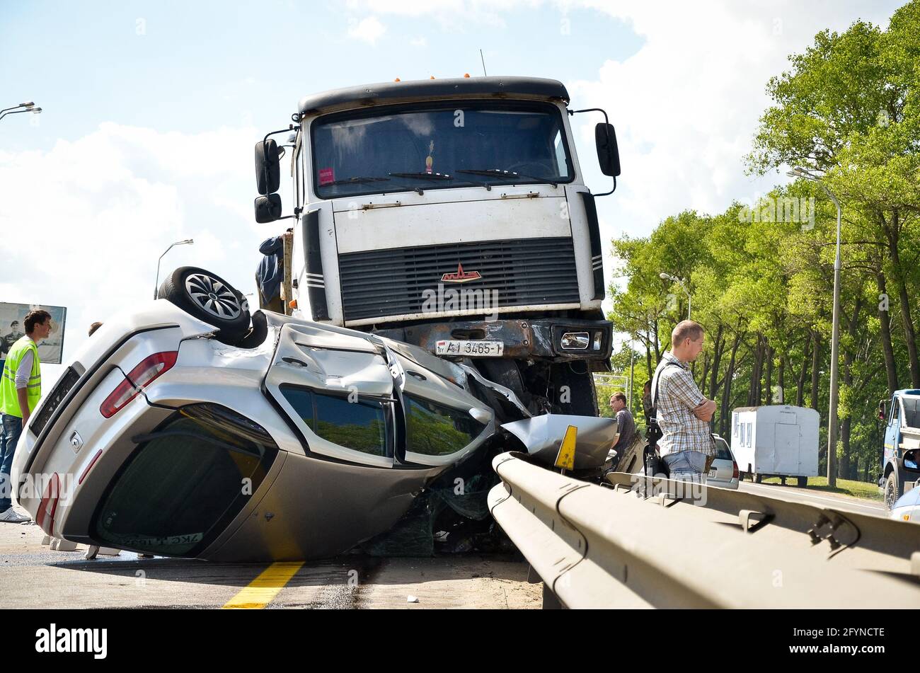 Car accident on the bypass road. A man sits near a wrecked Renault ...