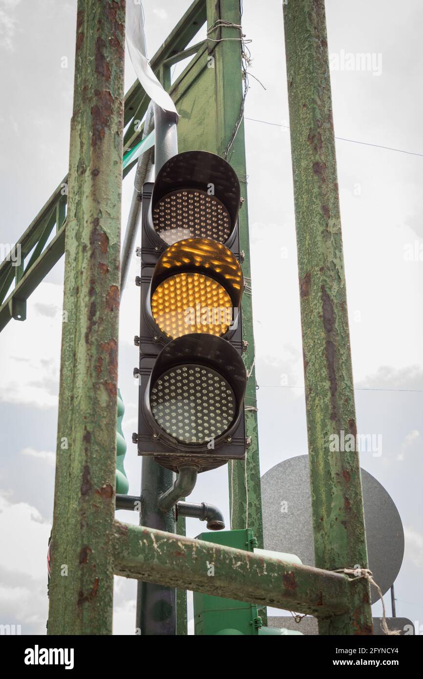 Low-angle shot of the traffic lights showing the yellow color against ...
