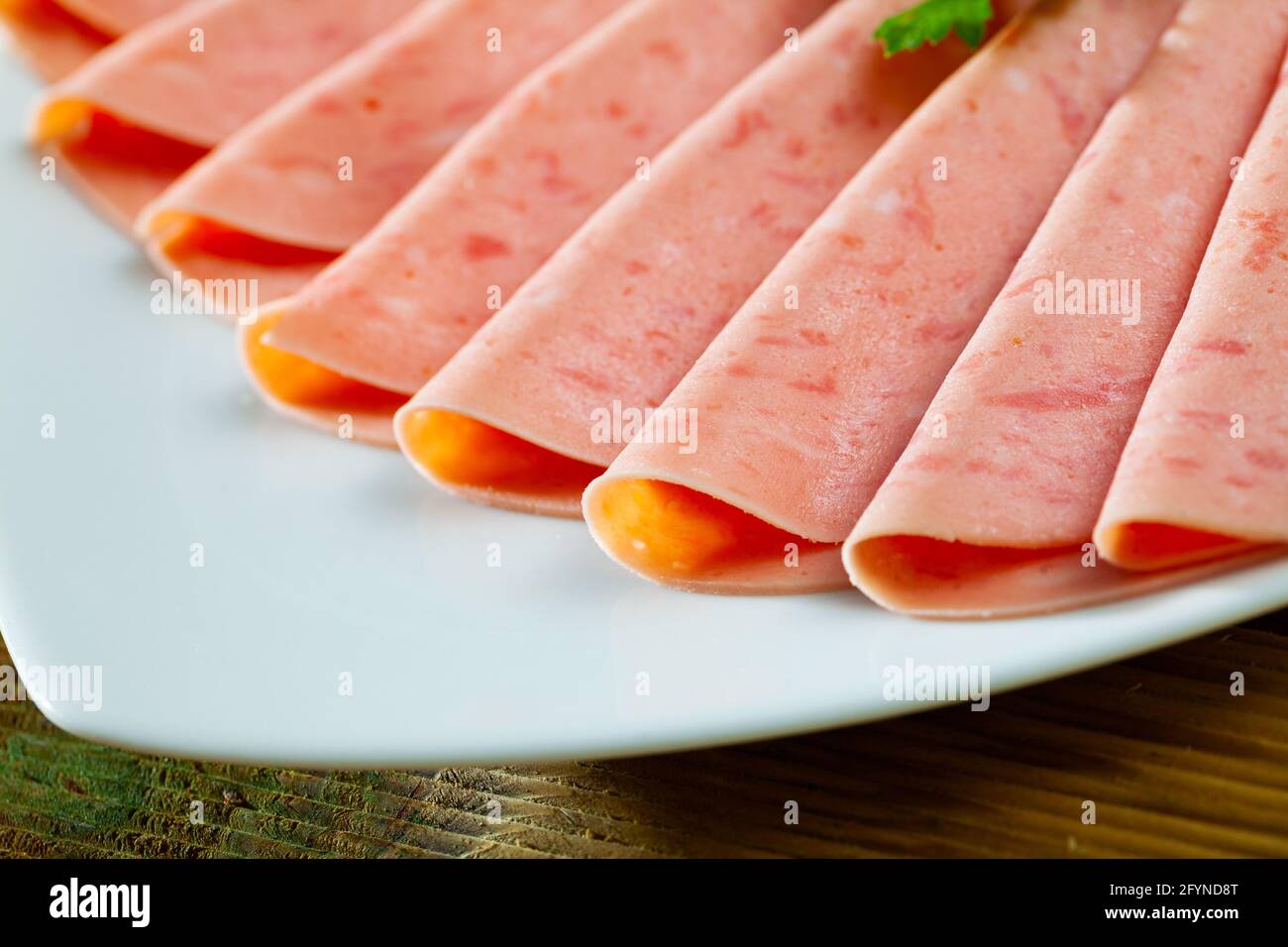 Thin sliced boiled pork ham on wooden background Stock Photo - Alamy