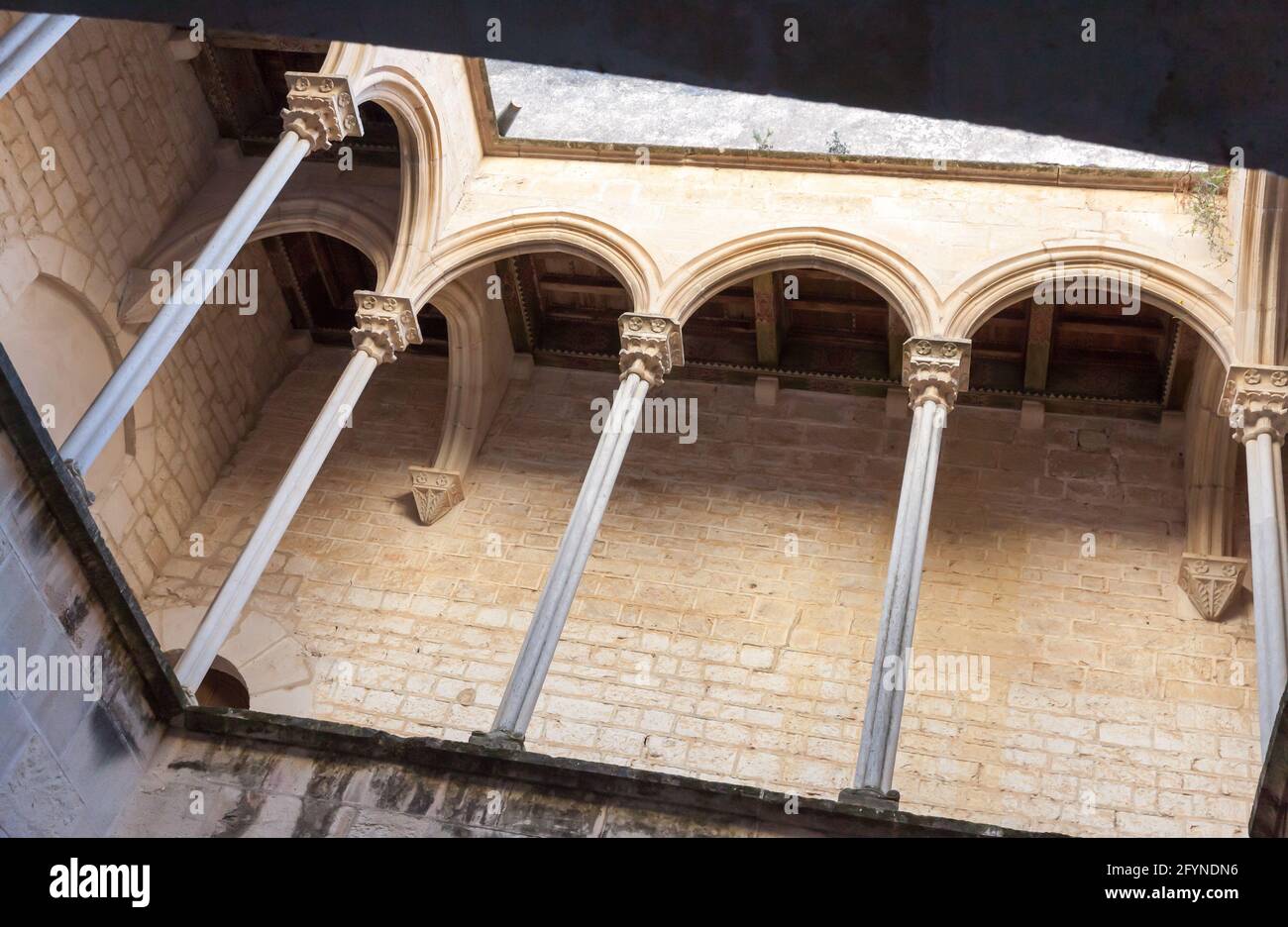 Gothic arched gallery with porphyry columns leading on royal residence ...