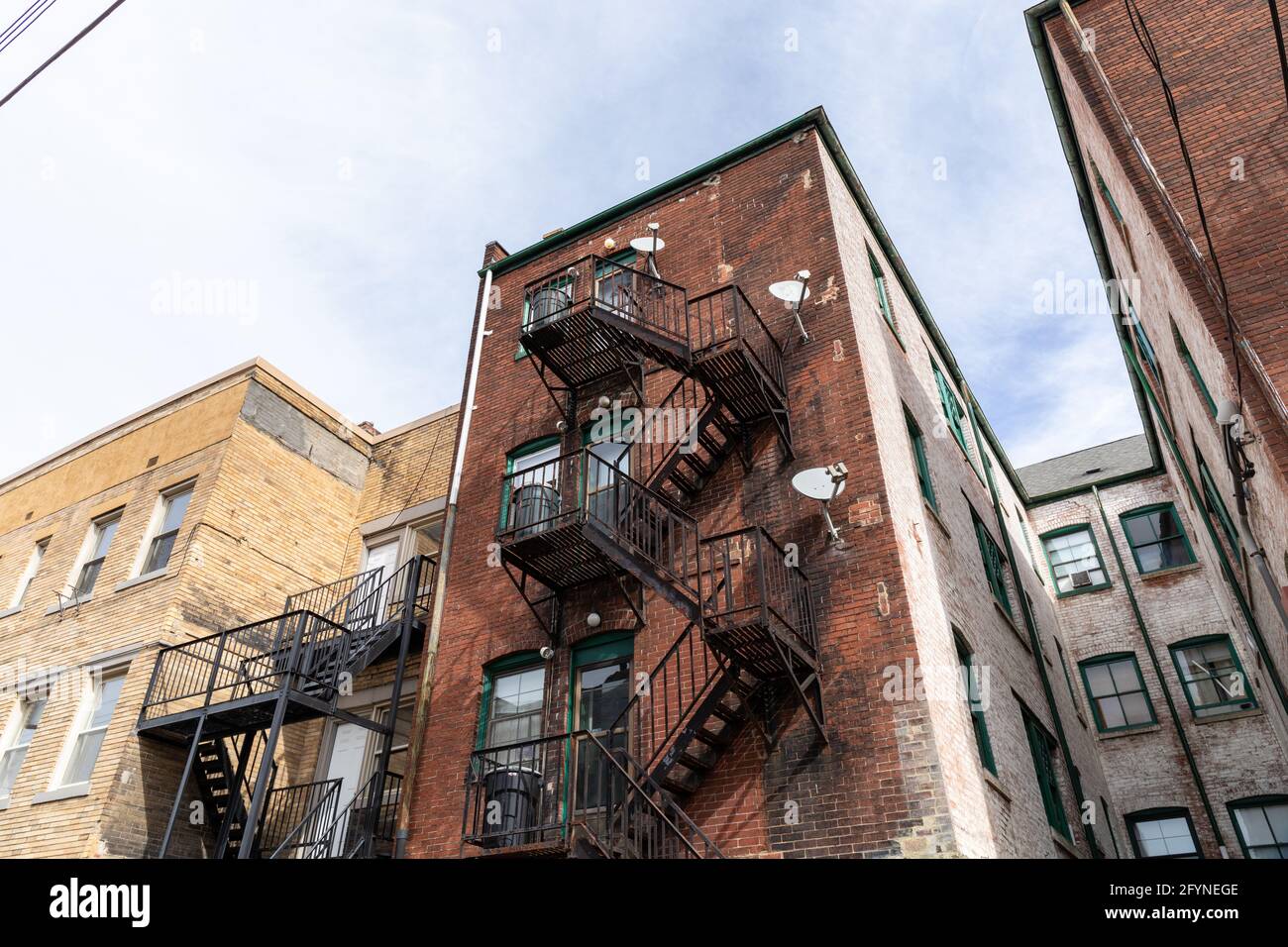 Rear view of old brick apartment buildings with metal fire escapes ...