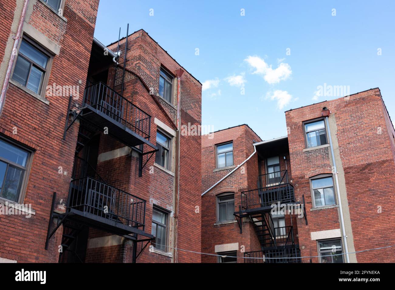 Urban landscape rear view of old brick apartment buildings with black ...